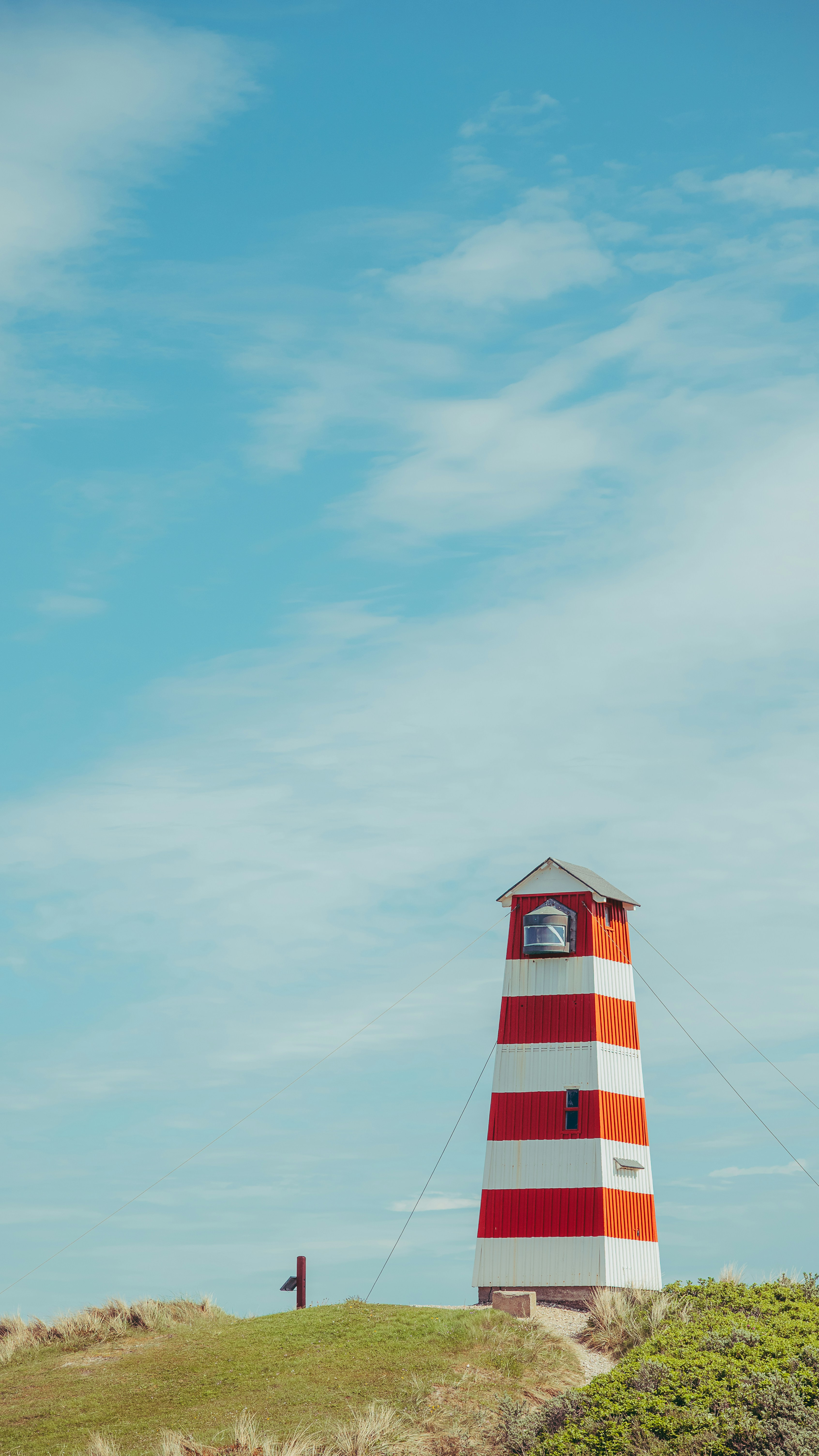 Red-and-White Beacon on a Quiet Coastal Ridge