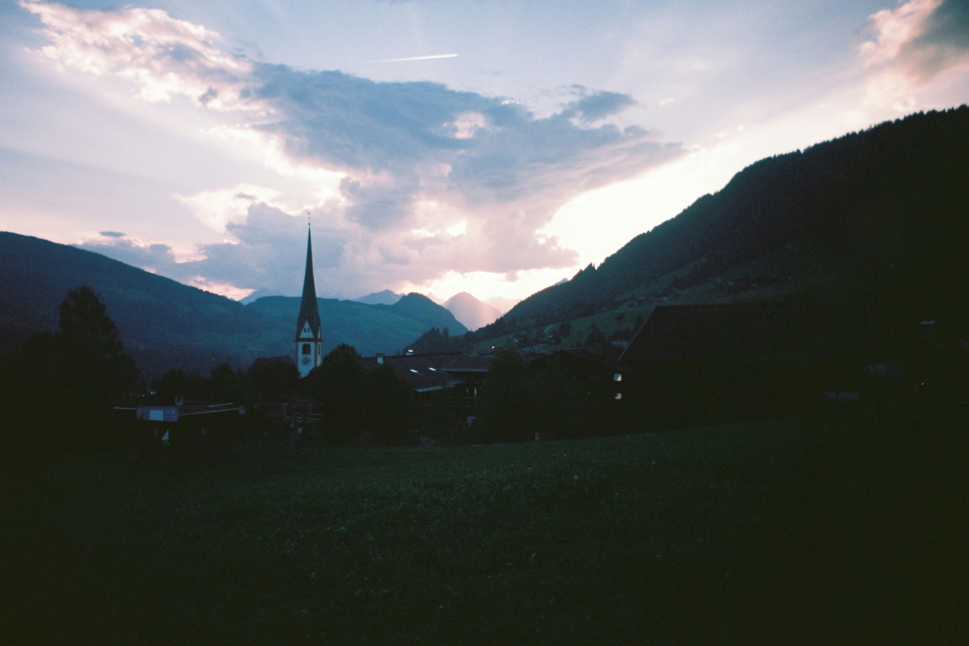 Evening Village in the Valley, Beneath a Looming Peak
