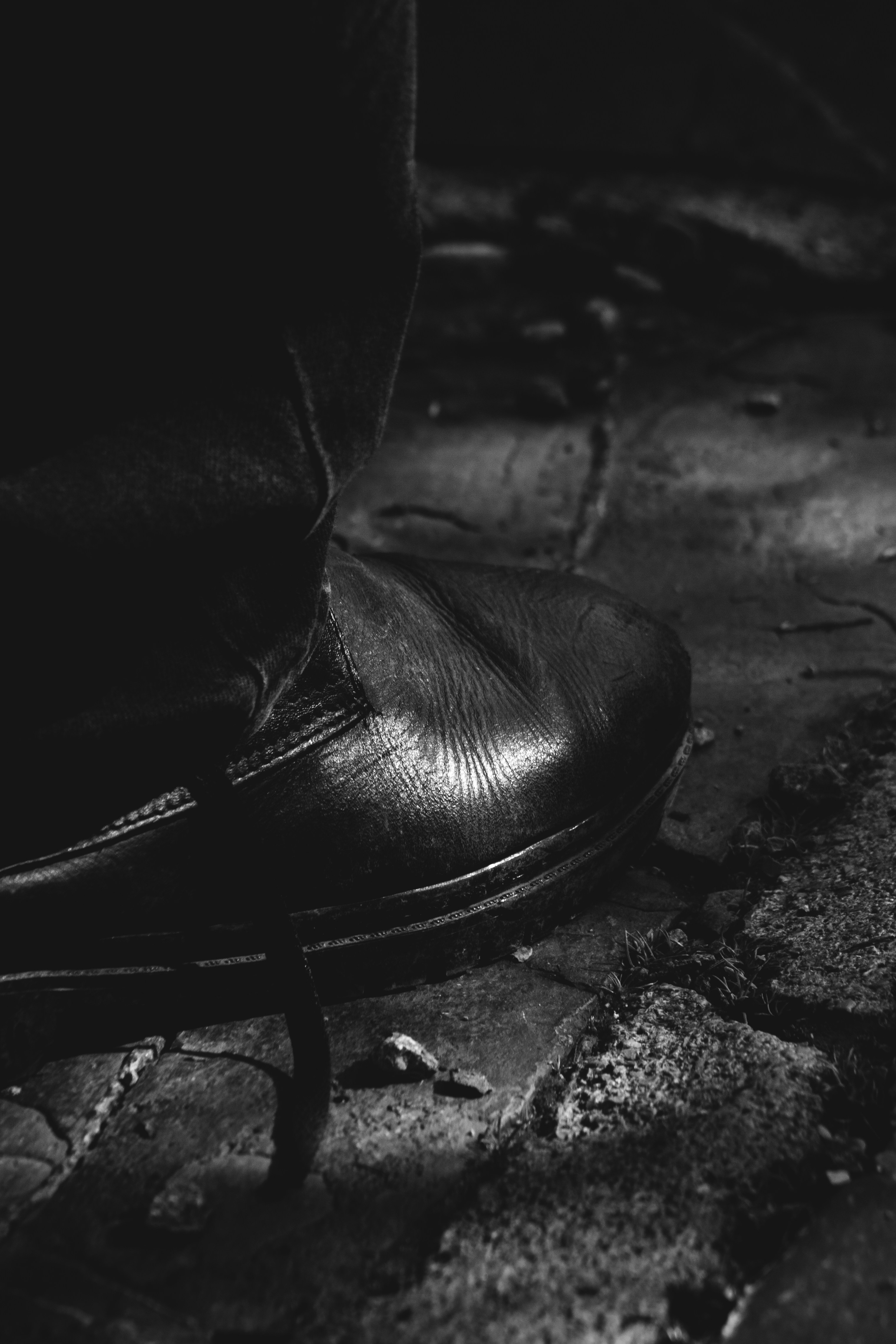 Stepped Quiet: A Glimpse of a Shined Boot on Cobblestones