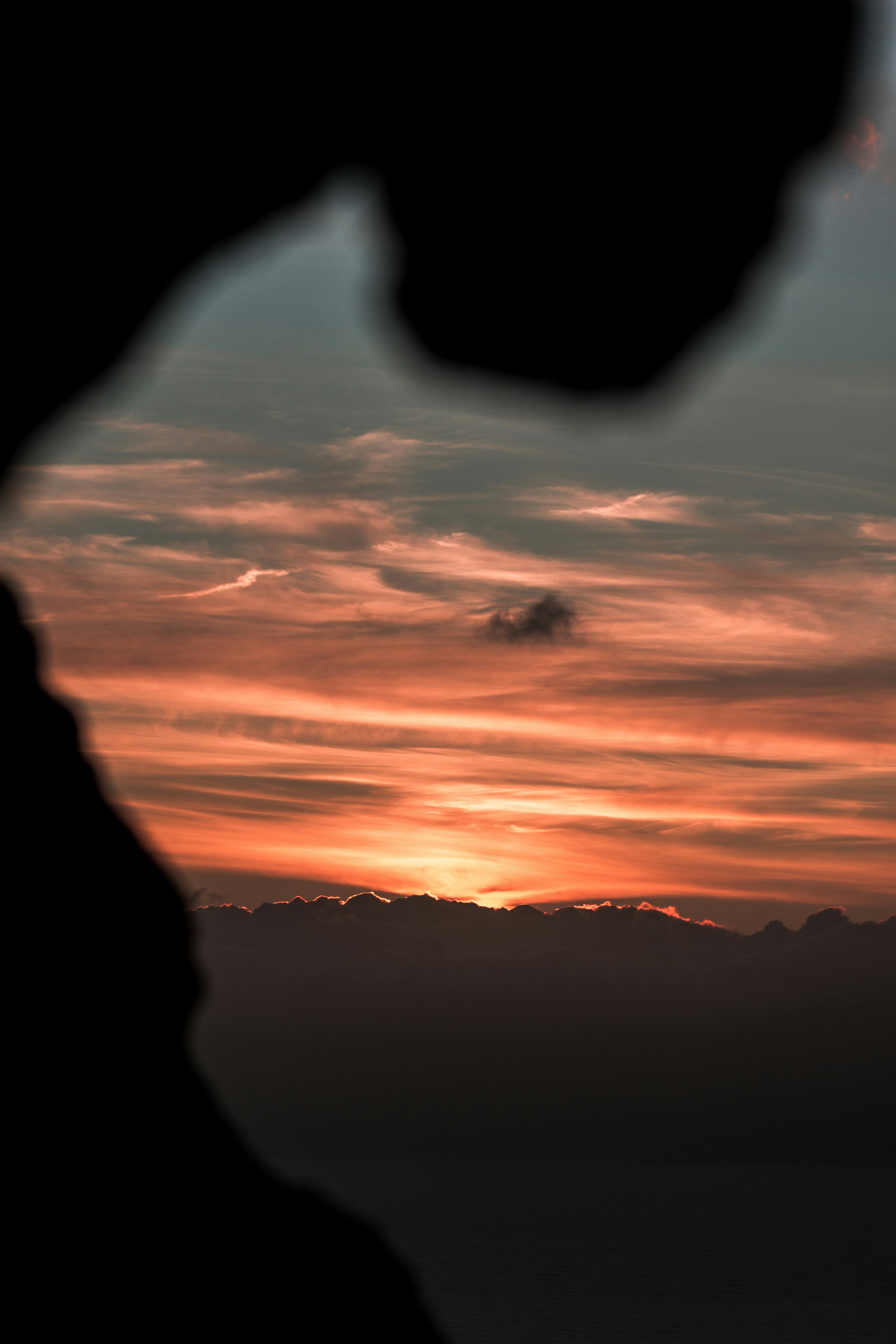 Silhouette Gaps: Sunset Framed by Dark Archways