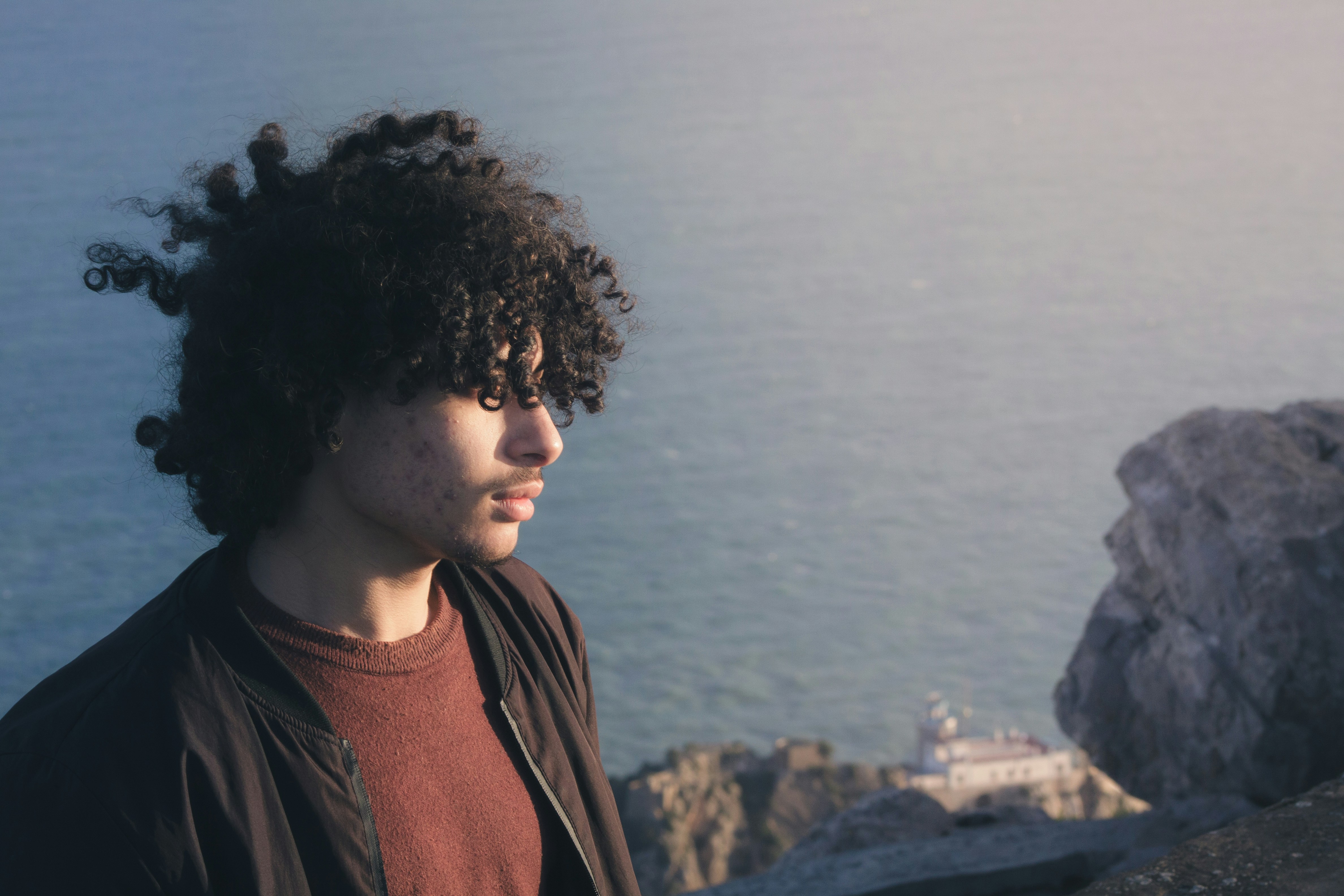 Muted Coastline Portrait: Quiet Confidence Against the Cliffs