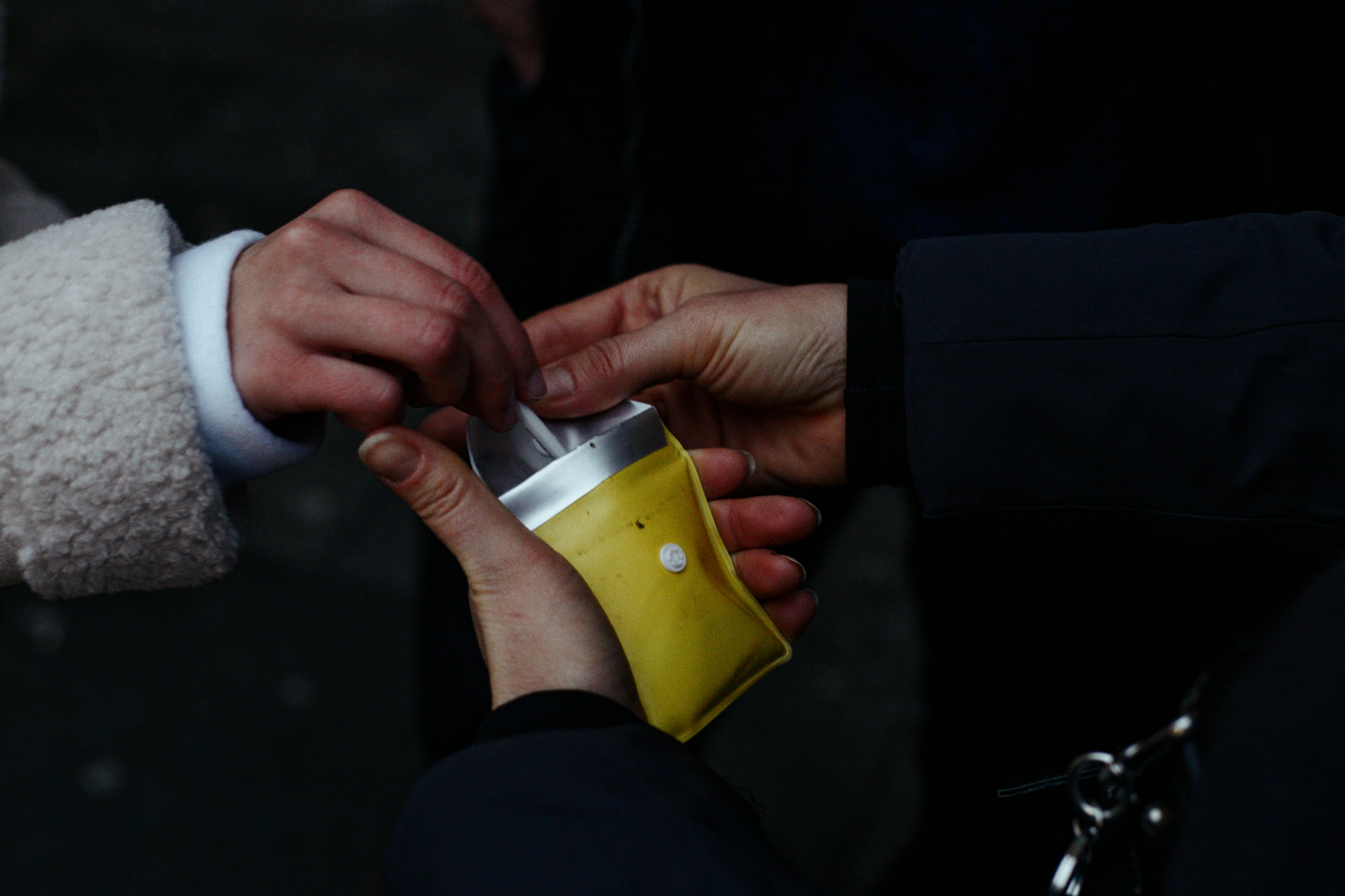 Hands Exchange: A Quick Moment of Trust with a Yellow Package
