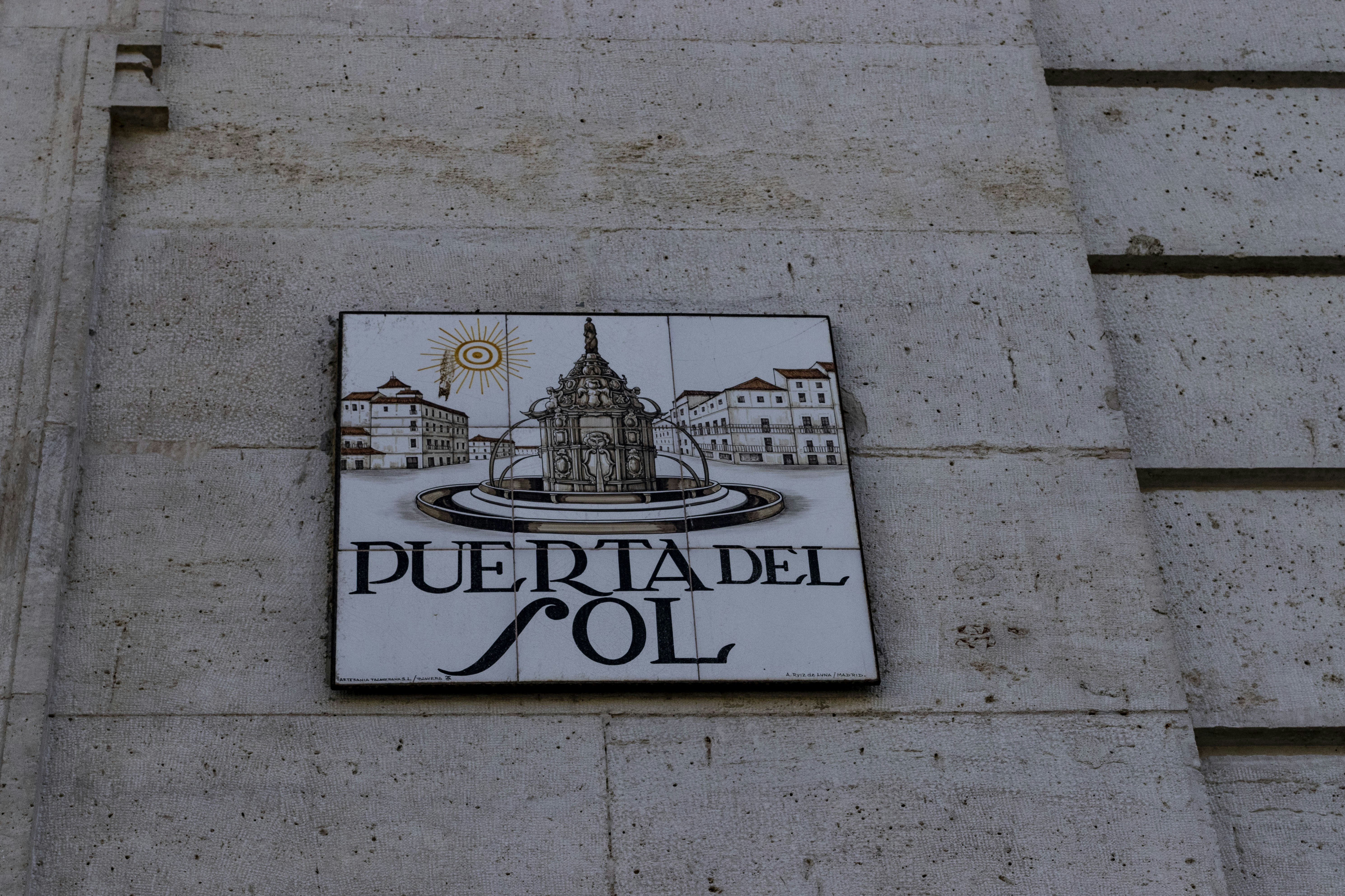 Tile Emblem: Puerta del Sol Sign Set into Stone Facade