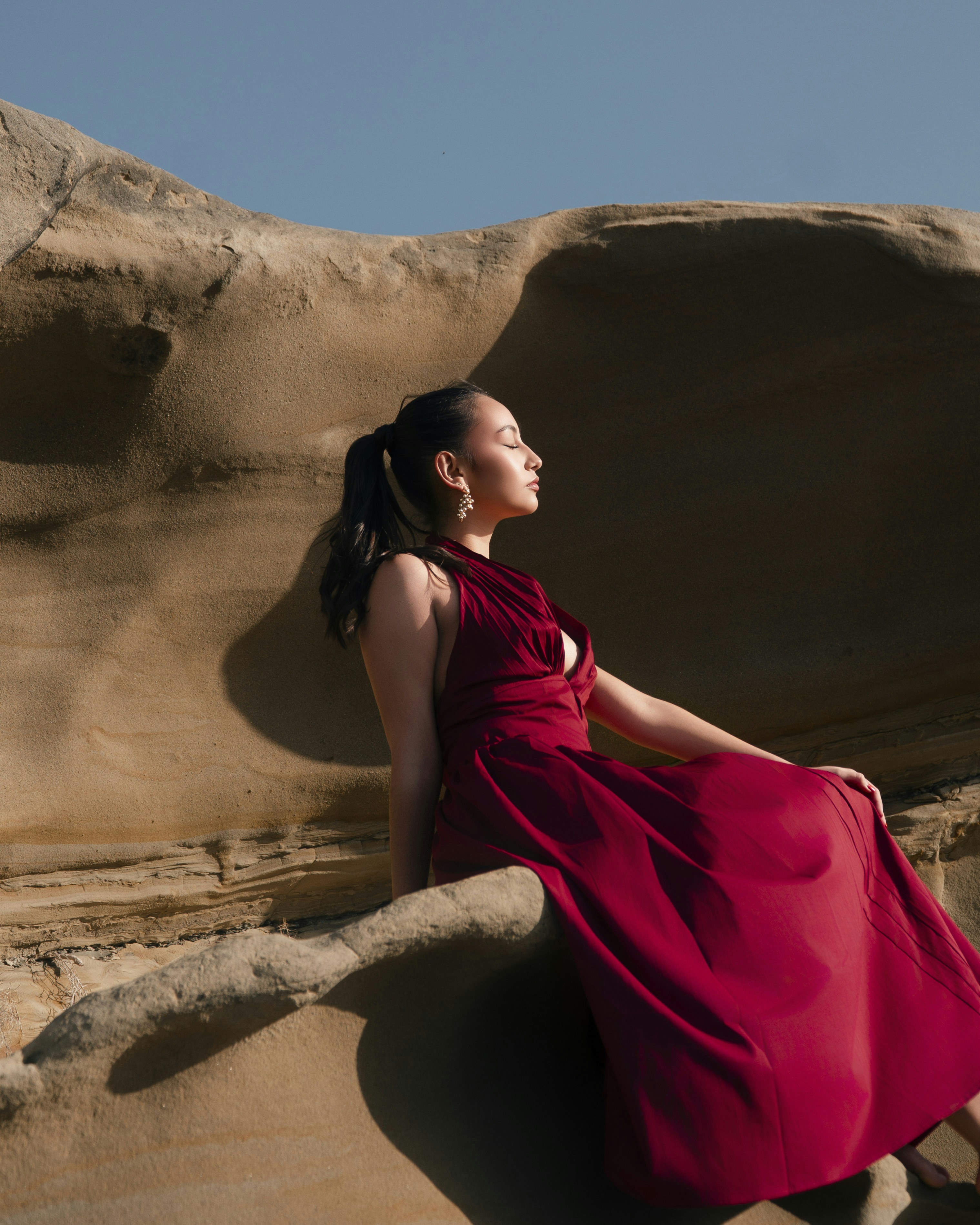 Crimson Silk Against Sandlight Cliffs