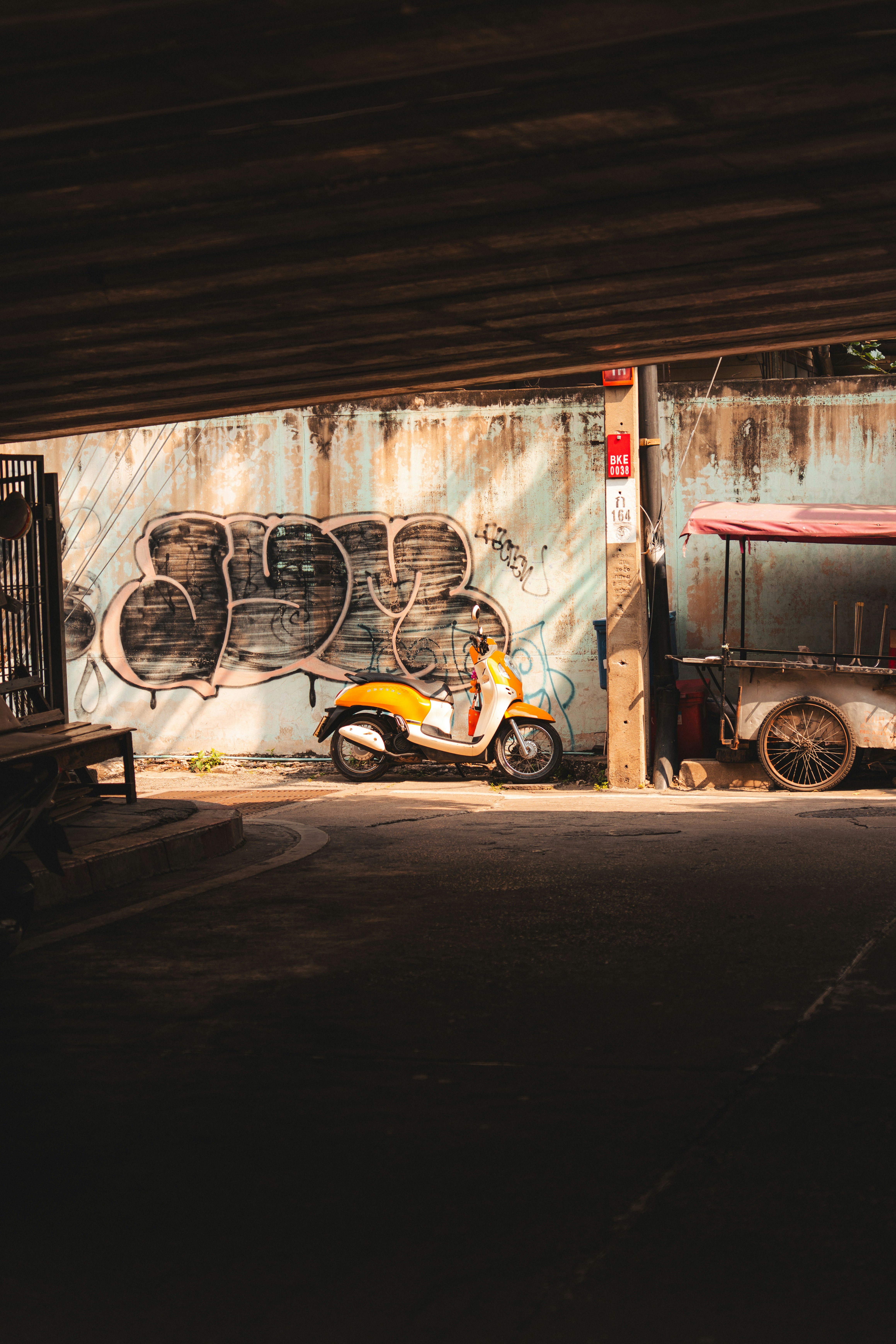 Sunny Vespa by Graffiti Wall Underpass
