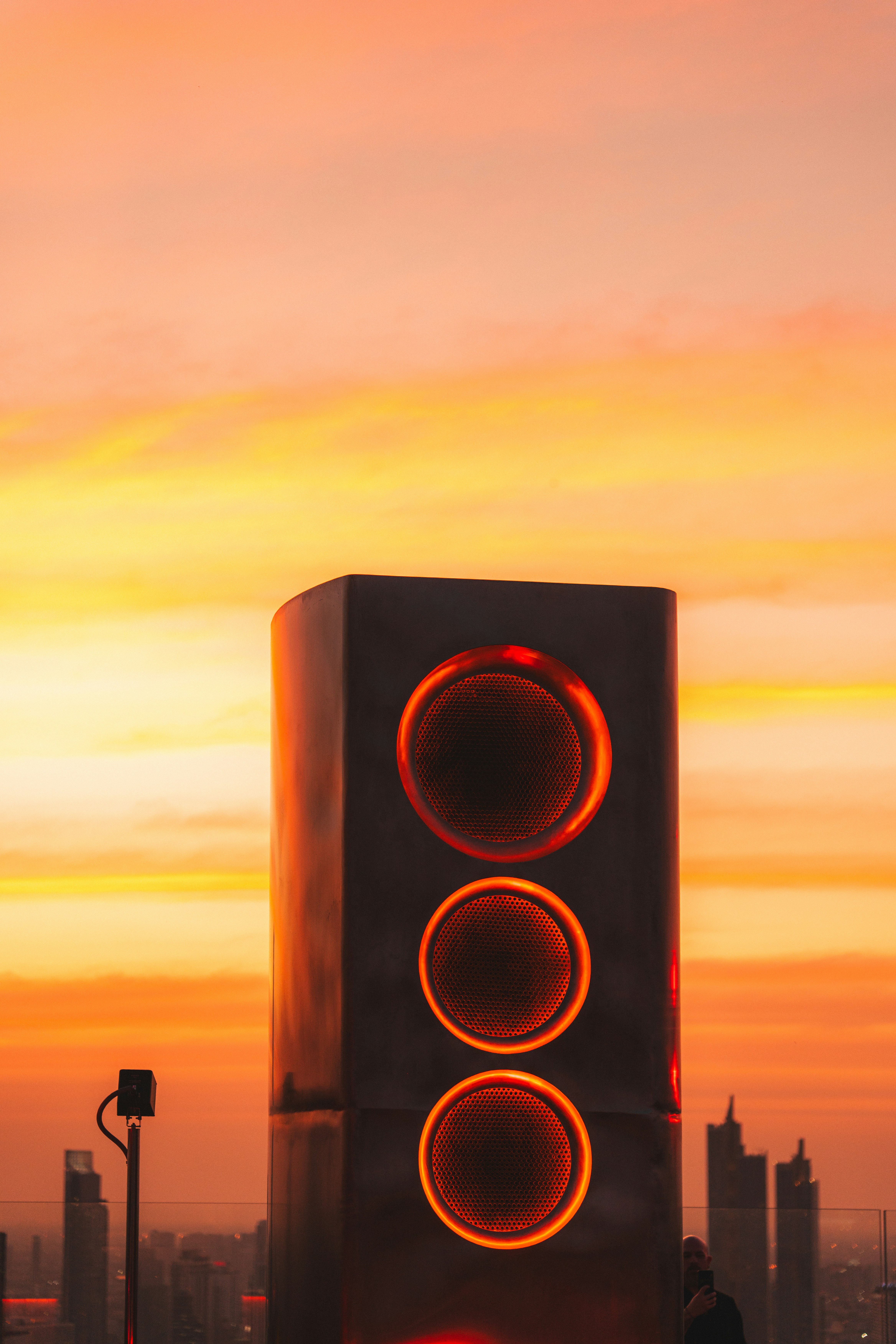 Neonified Skyline: A Trio of Subwoofers Basking in Sunset