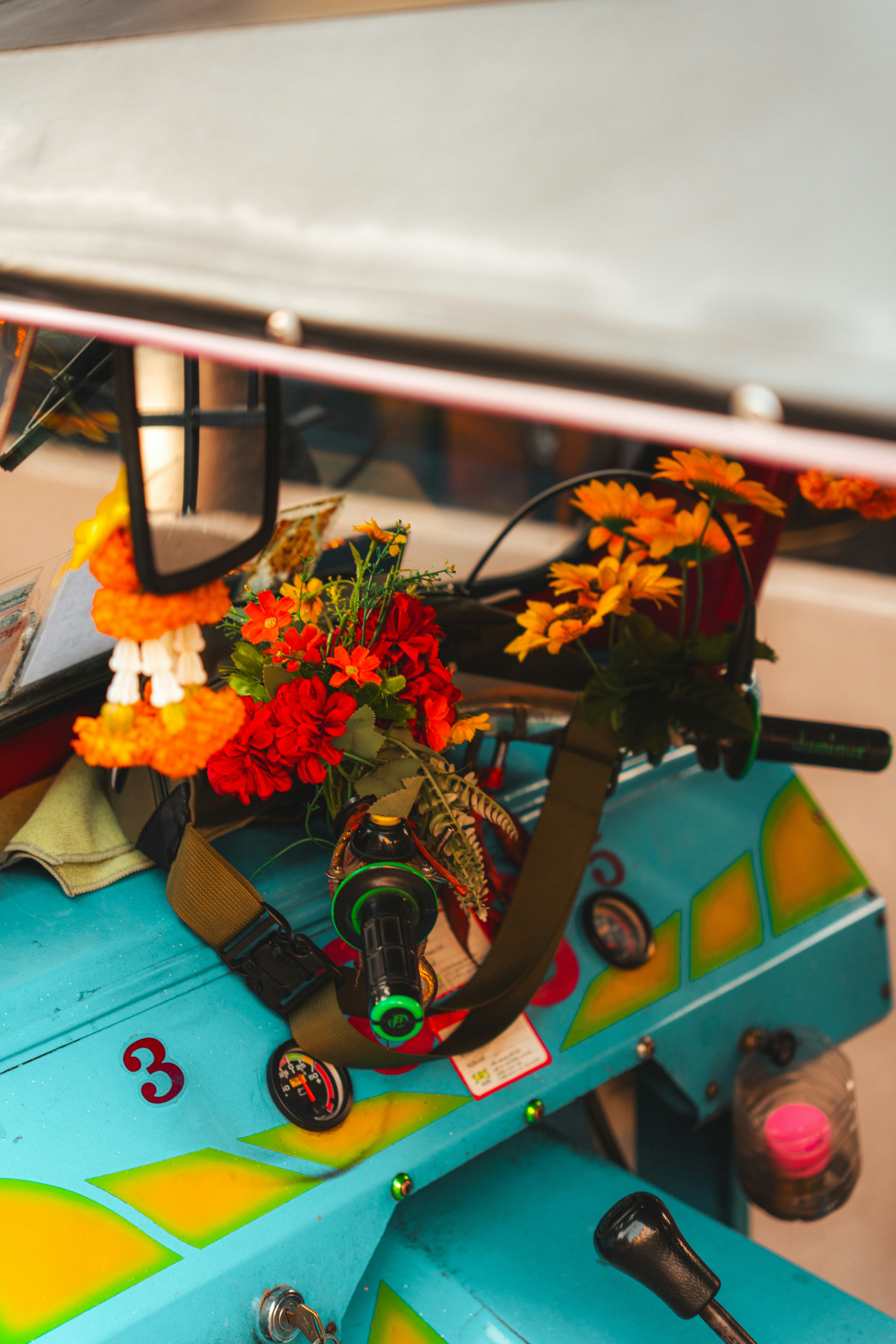 Flowered Gear: A Carnival of Colors on a Tiny Blue Vehicle