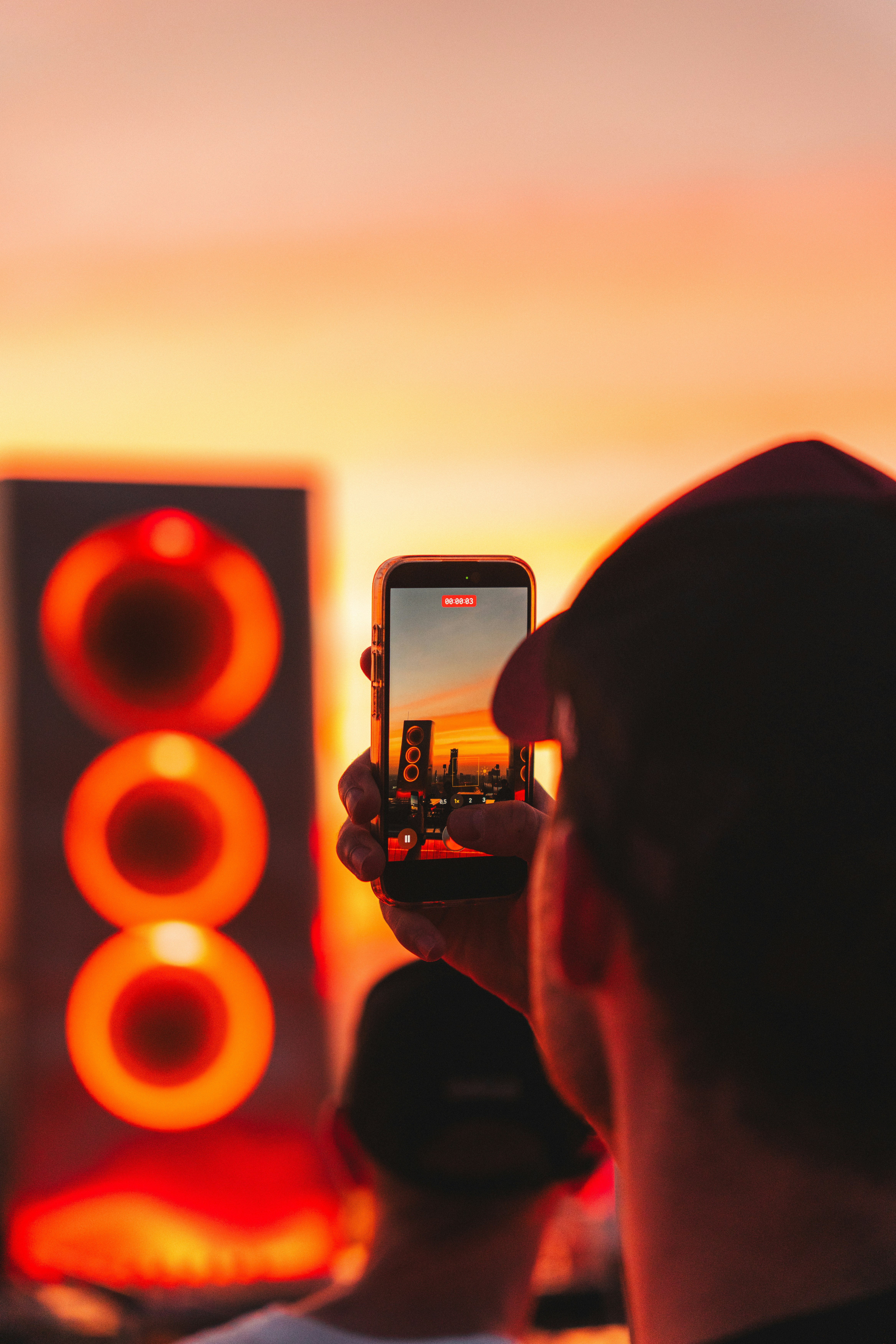 Glow of the Screen: A Handheld Moment Captured at Sunset