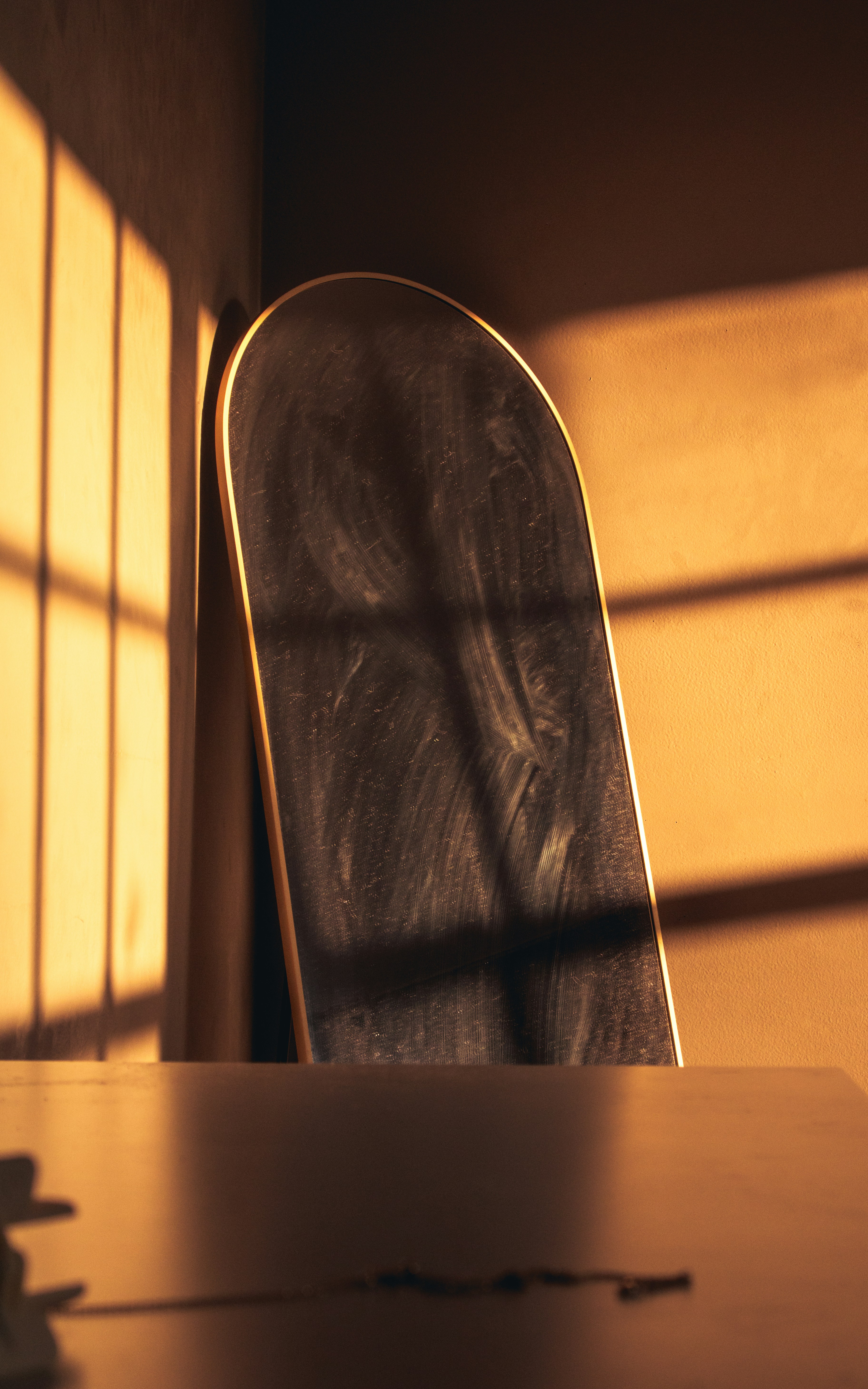 Golden Hour Deck: A Skateboard Resting in Warm Shadows