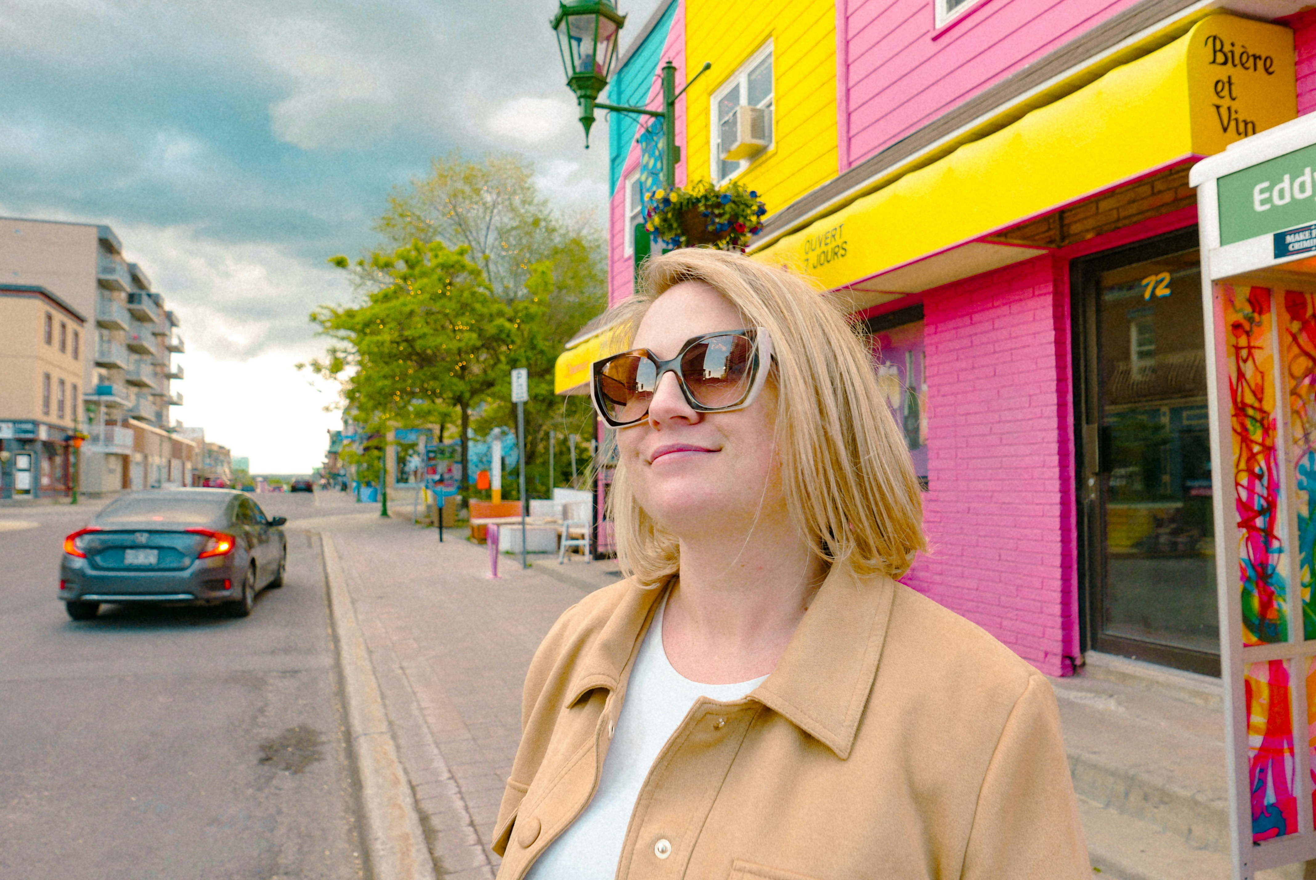 Sunlit Street Portrait with Colorful storefronts