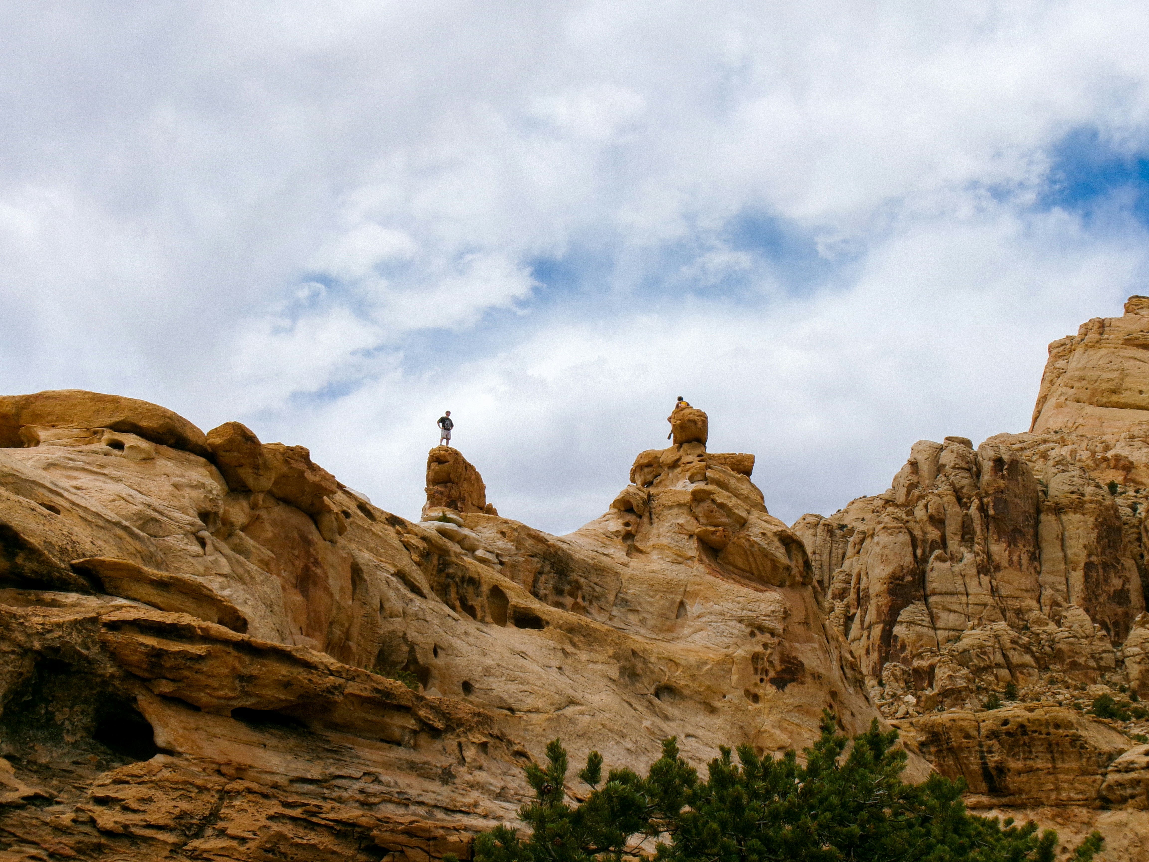 Top of the World: A Lone Figure Amid Desert Spires