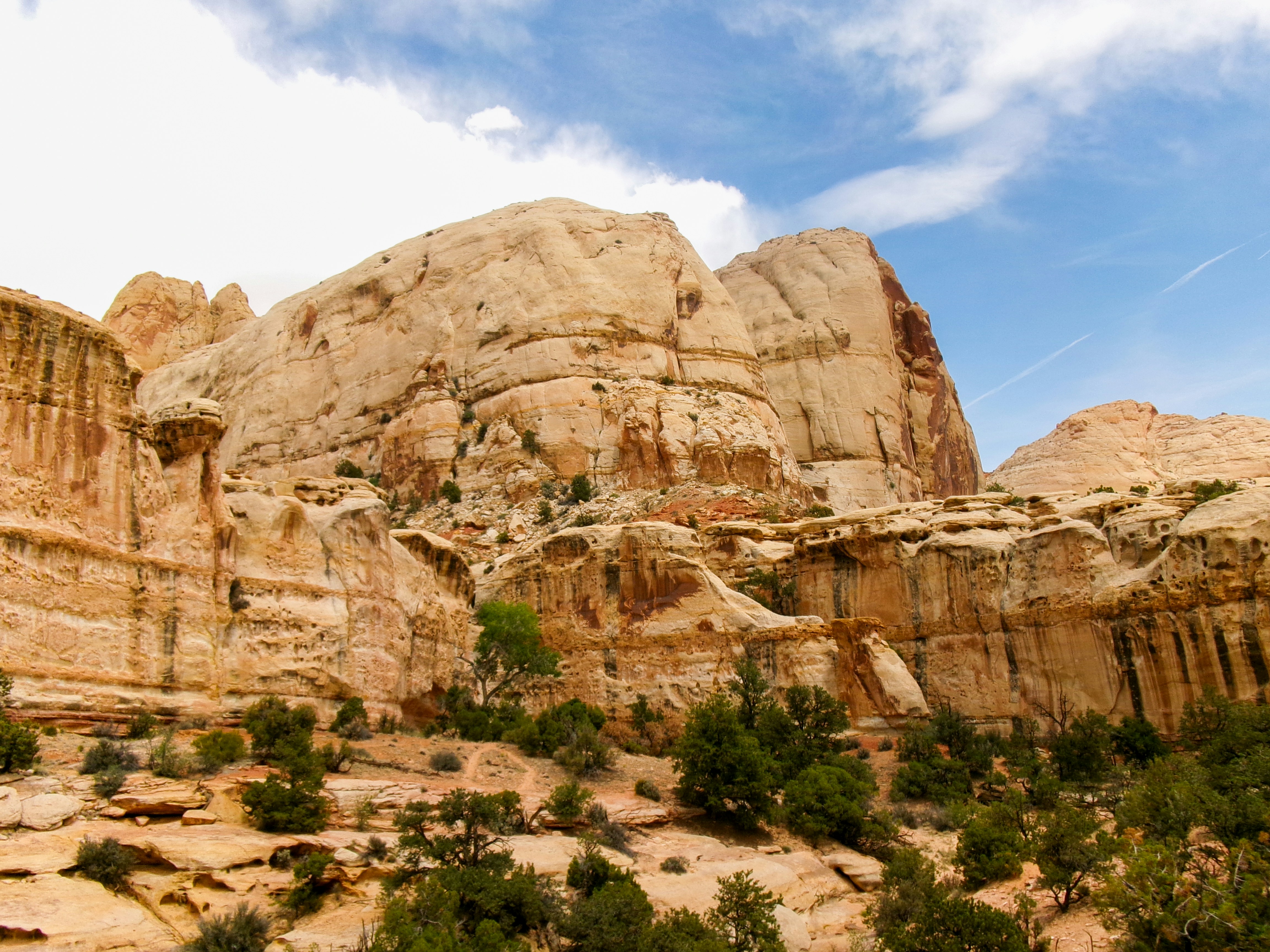 Sunlit sandstone stacks rising above a quiet desert floor