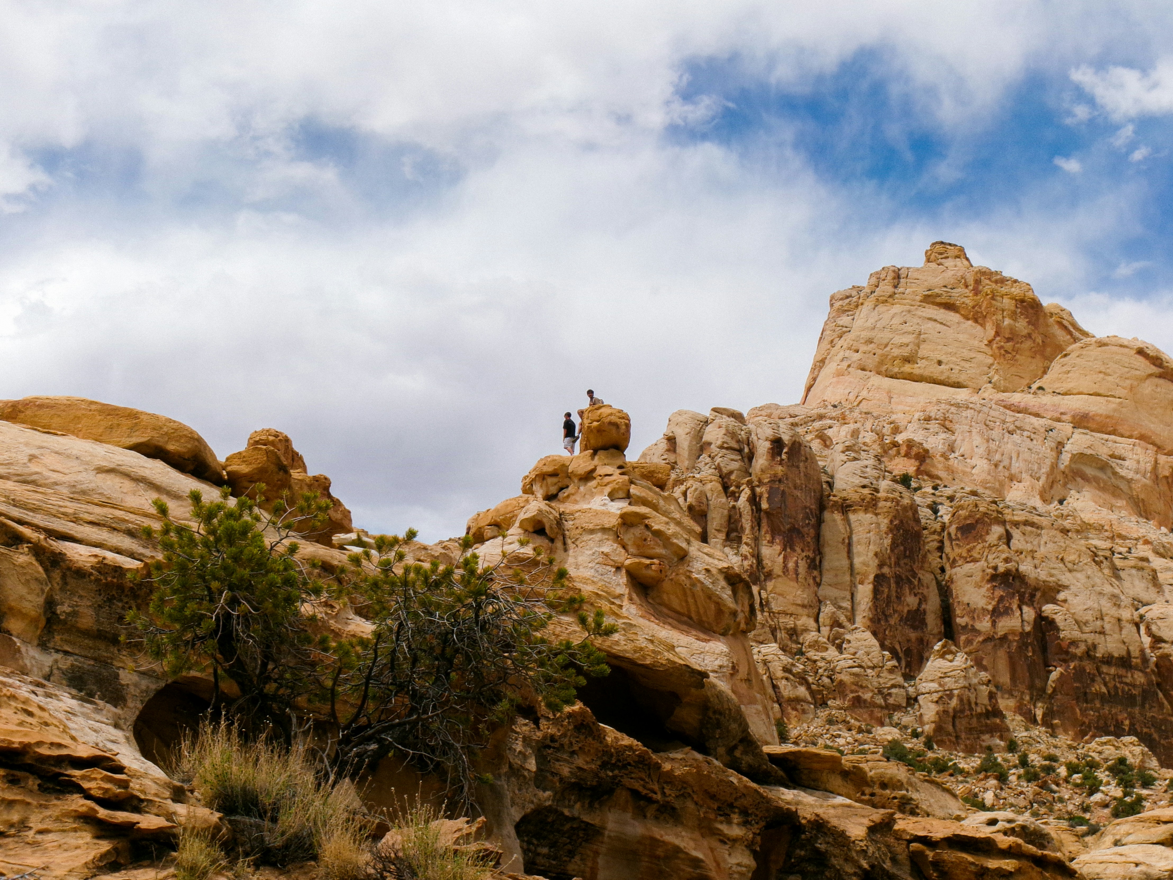 Ridgebound Reach: A lone climber on sunlit sandstone