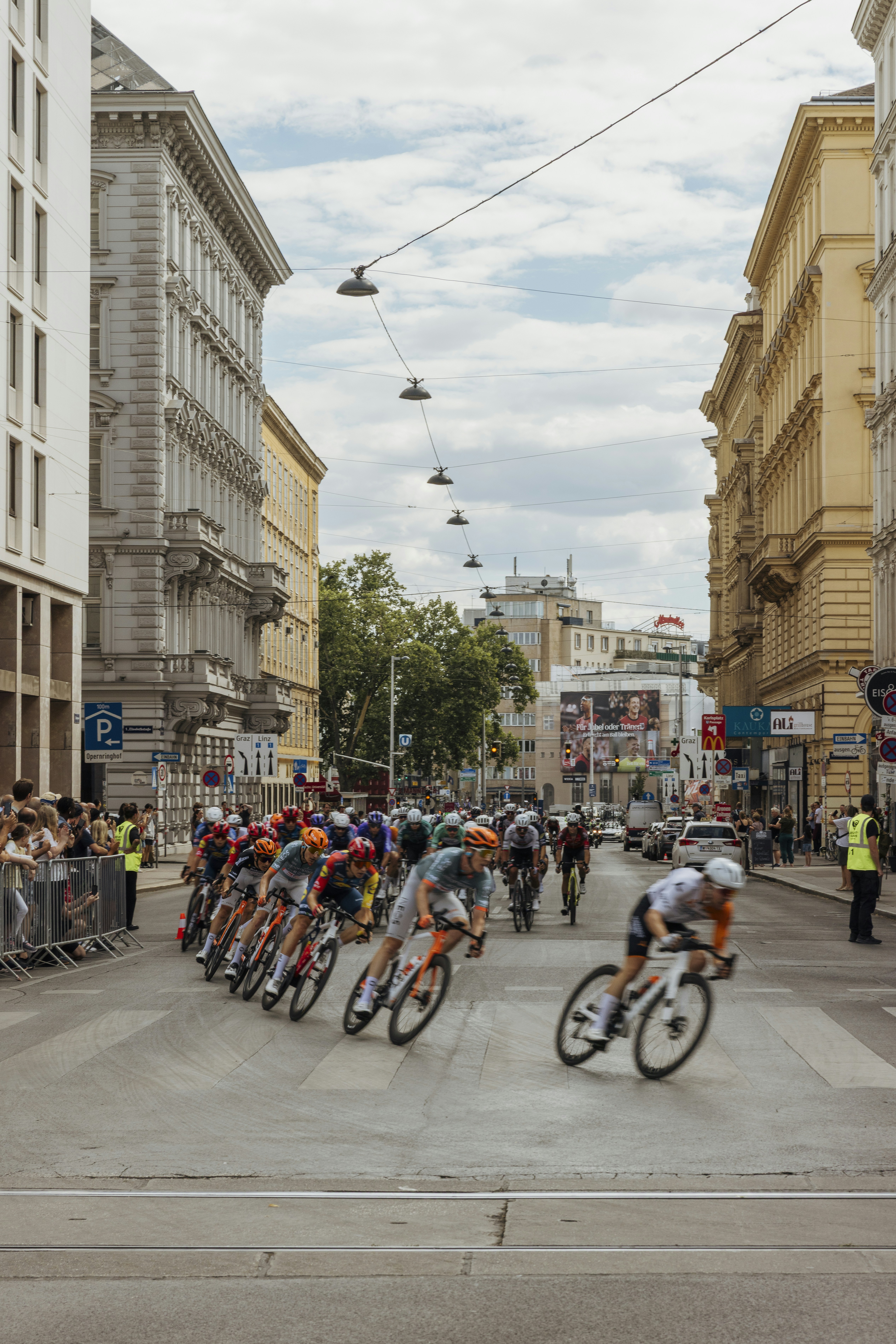 Peloton in Motion: A City Street Sprint Through Historic Facades