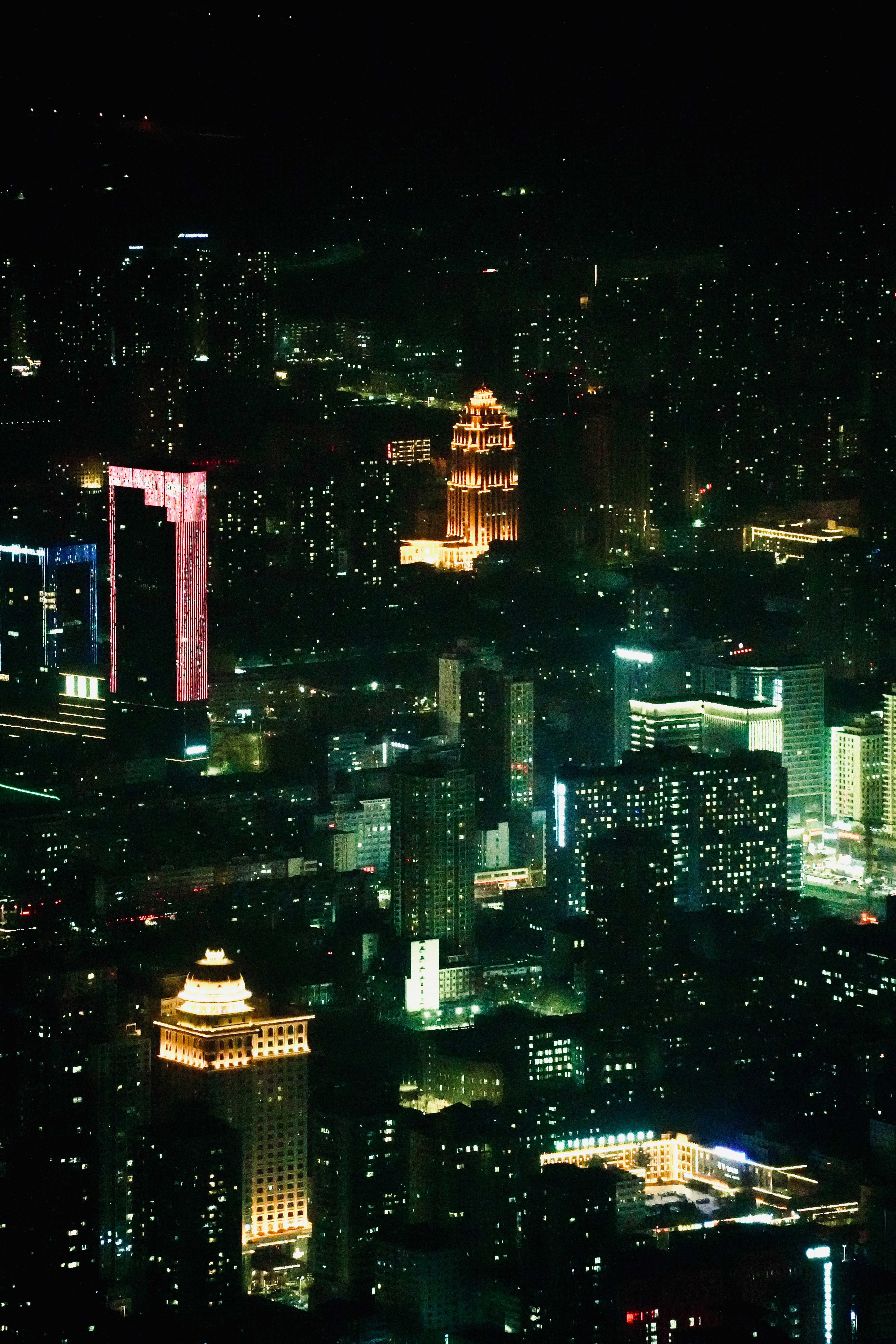 Neon Skyline Convergence: A Nighttime City Crowned by Golden Spires