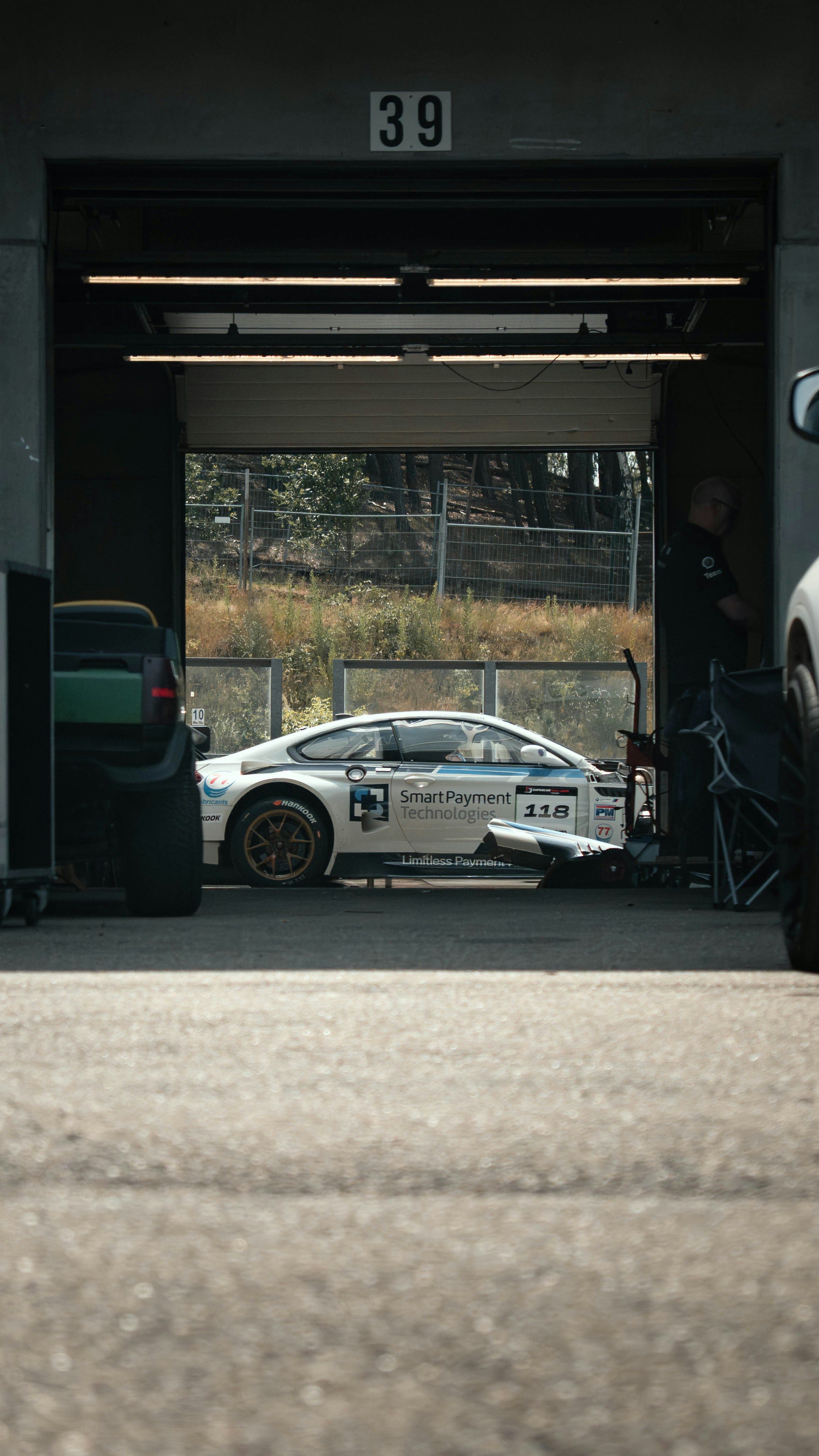 Inside the Pit Lane: Silver Racing Car in a Garage