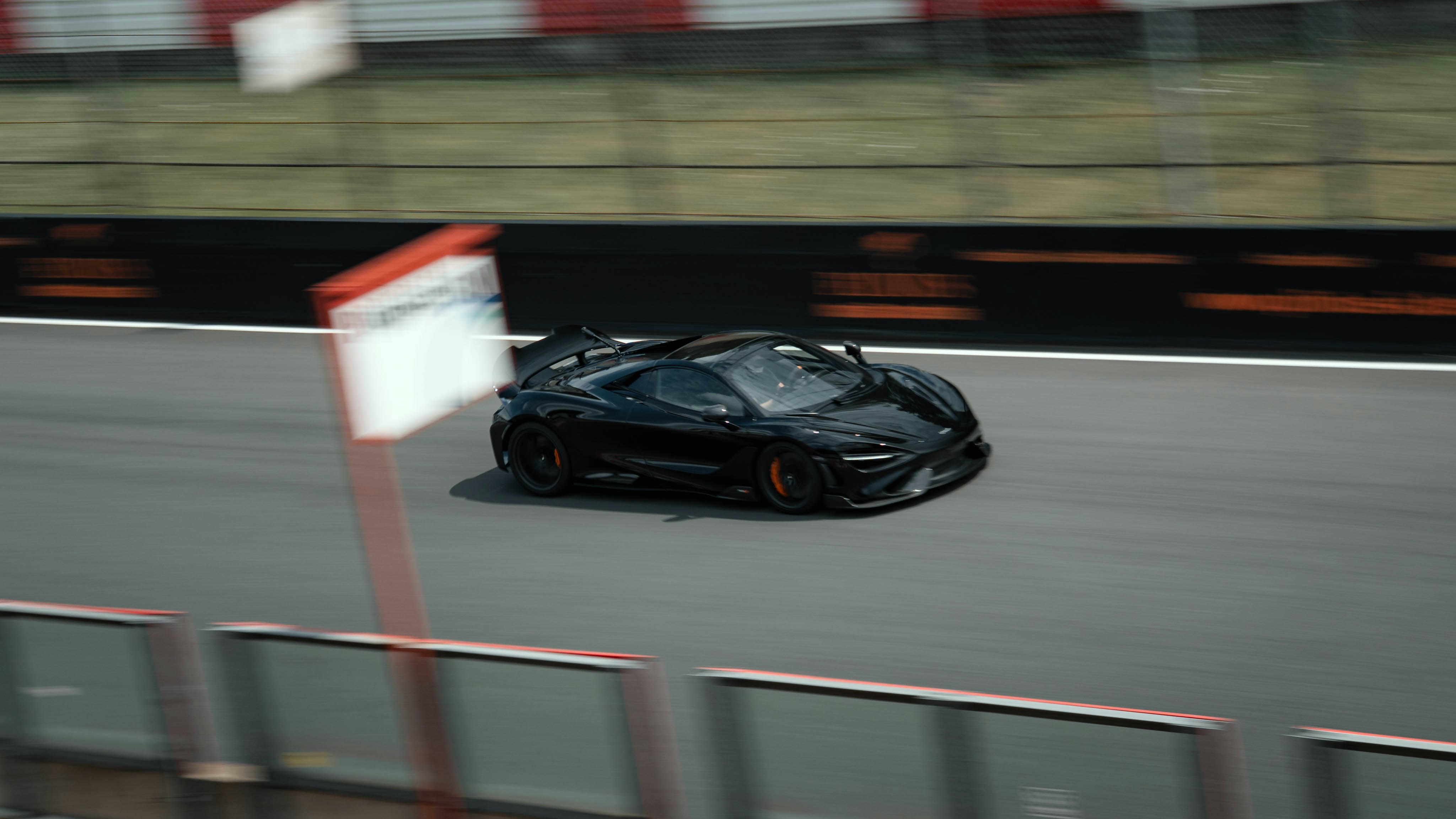 Dark Hypercar in a Blurred Sprint