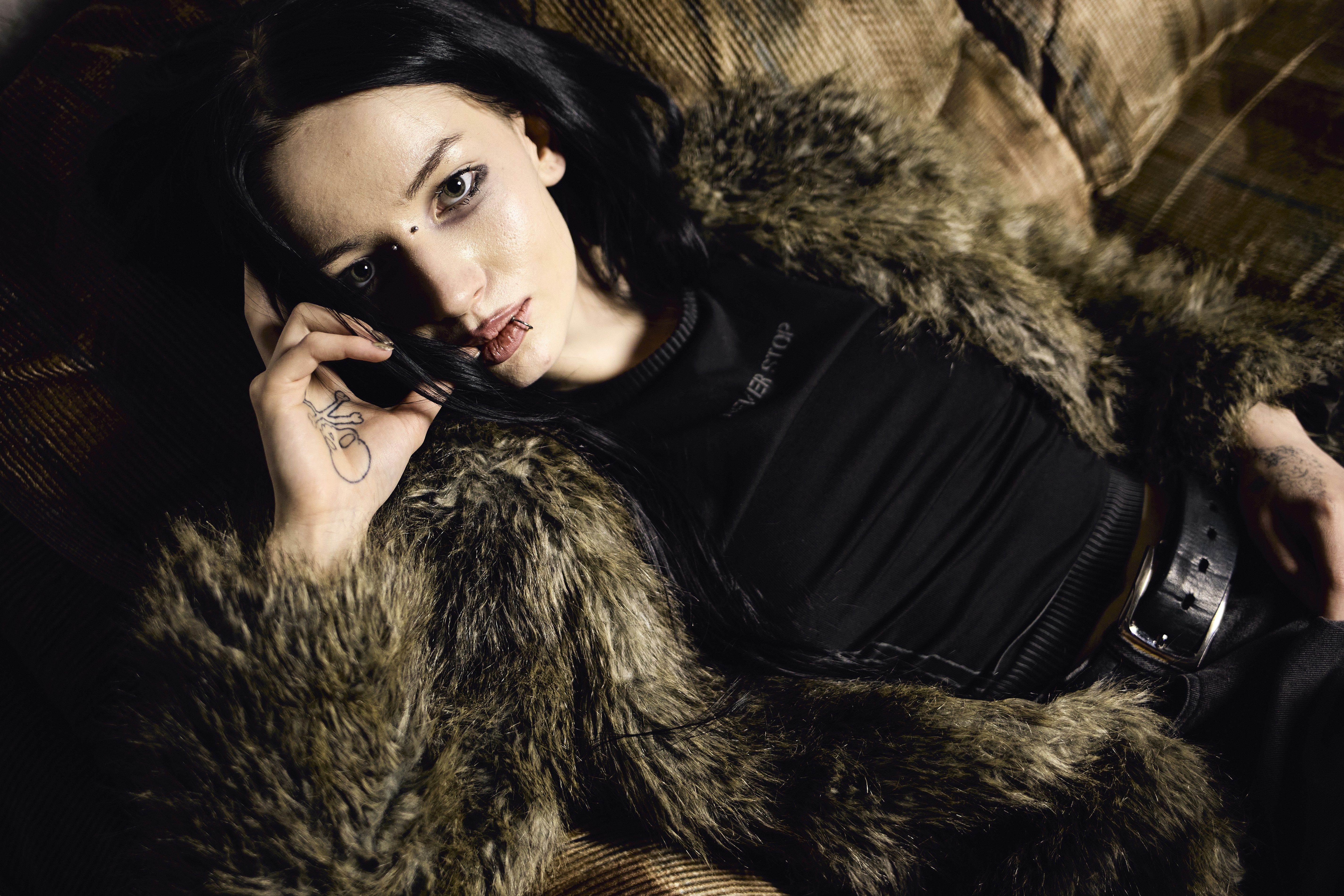 Velvet noir: a contemplative gaze framed by fur and shadows