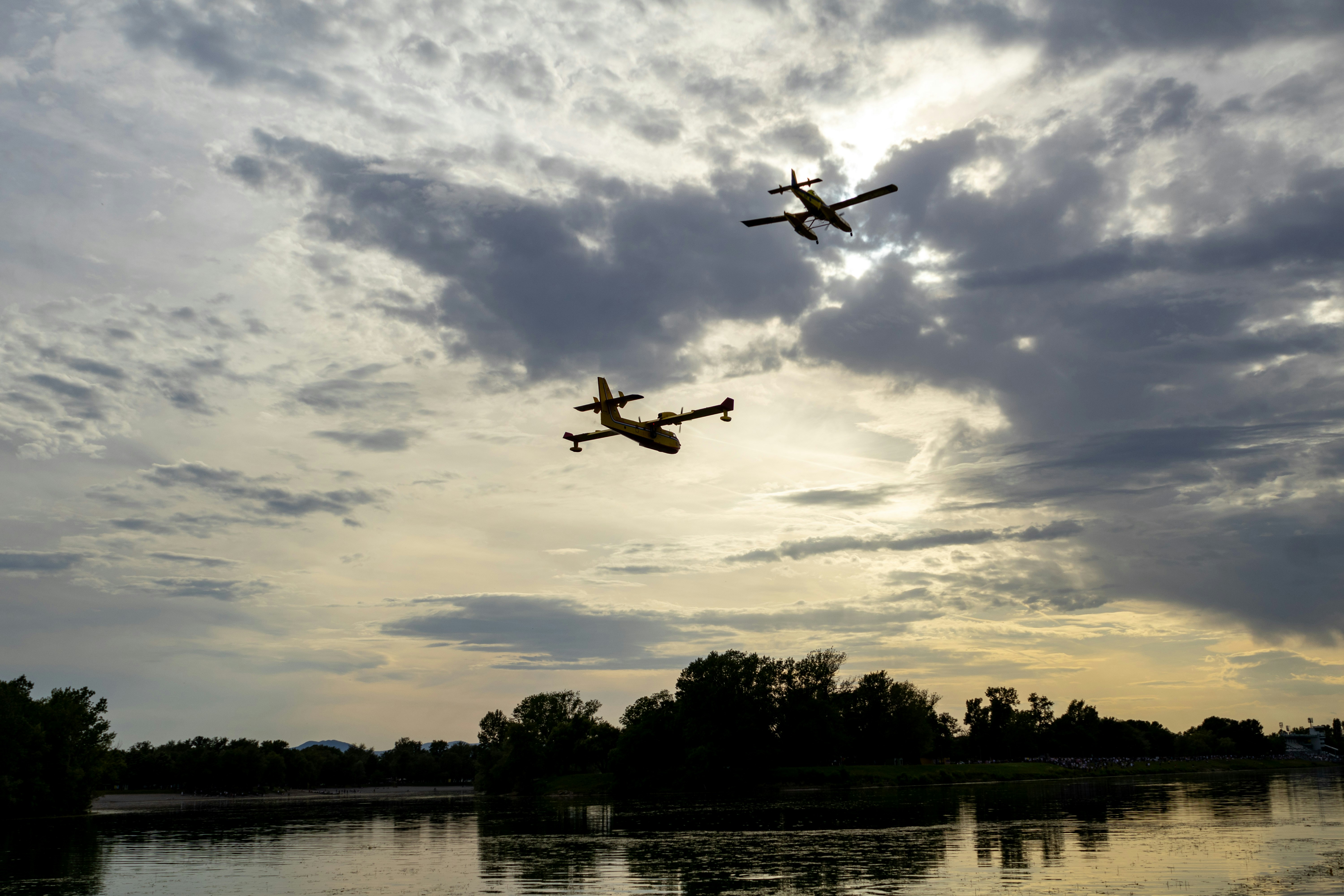 Skyward Aerial Pair: Twin Aircraft Crossing a Sunset