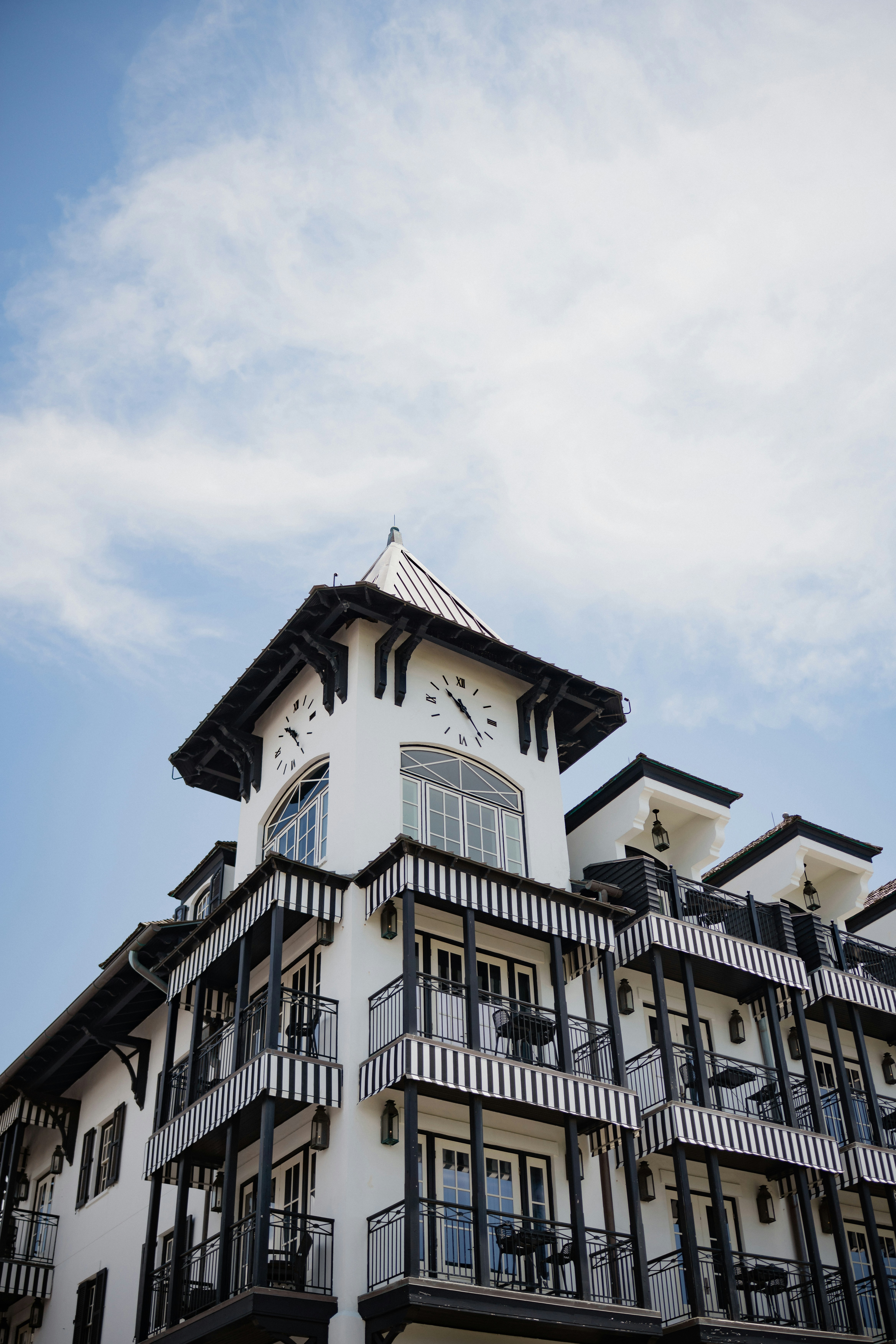 Clocktower Overlook: an angled city villa rising against a pale blue sky