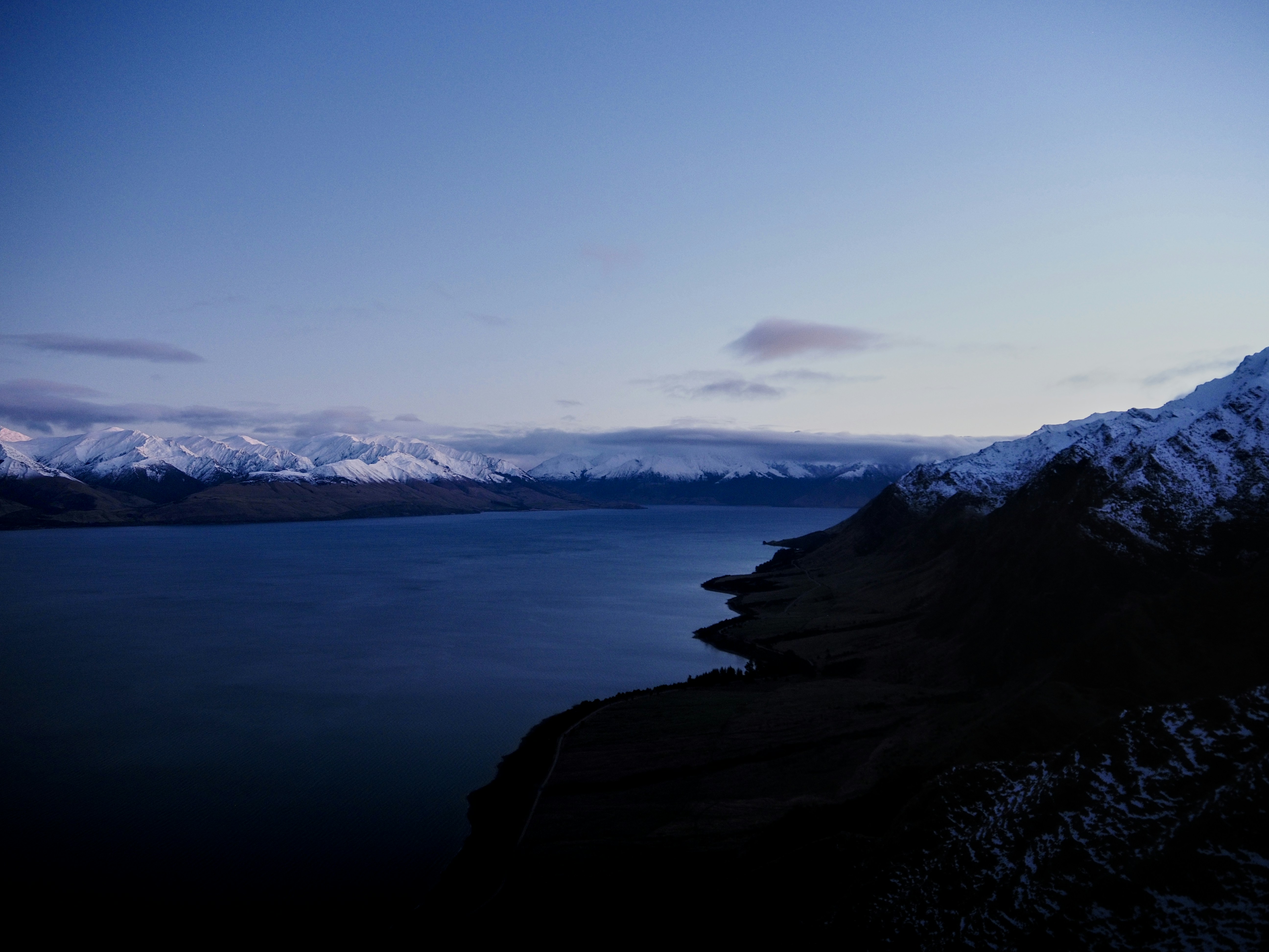 Dusk Over Silent Fjord: Snow-Capped Ridge Adrift