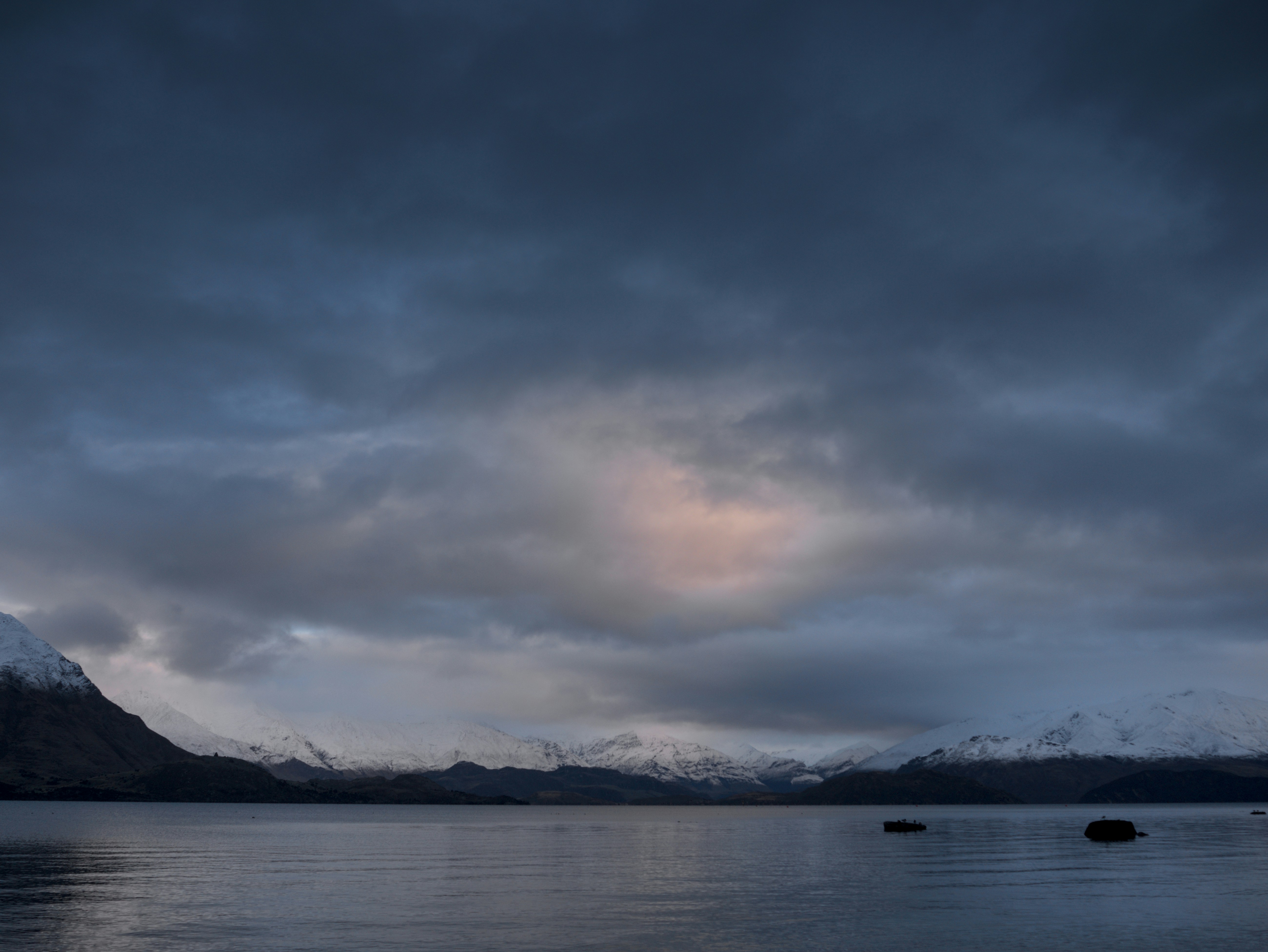 Silent Fjord at Dusk: A Calm Confluence of Clouds and Water