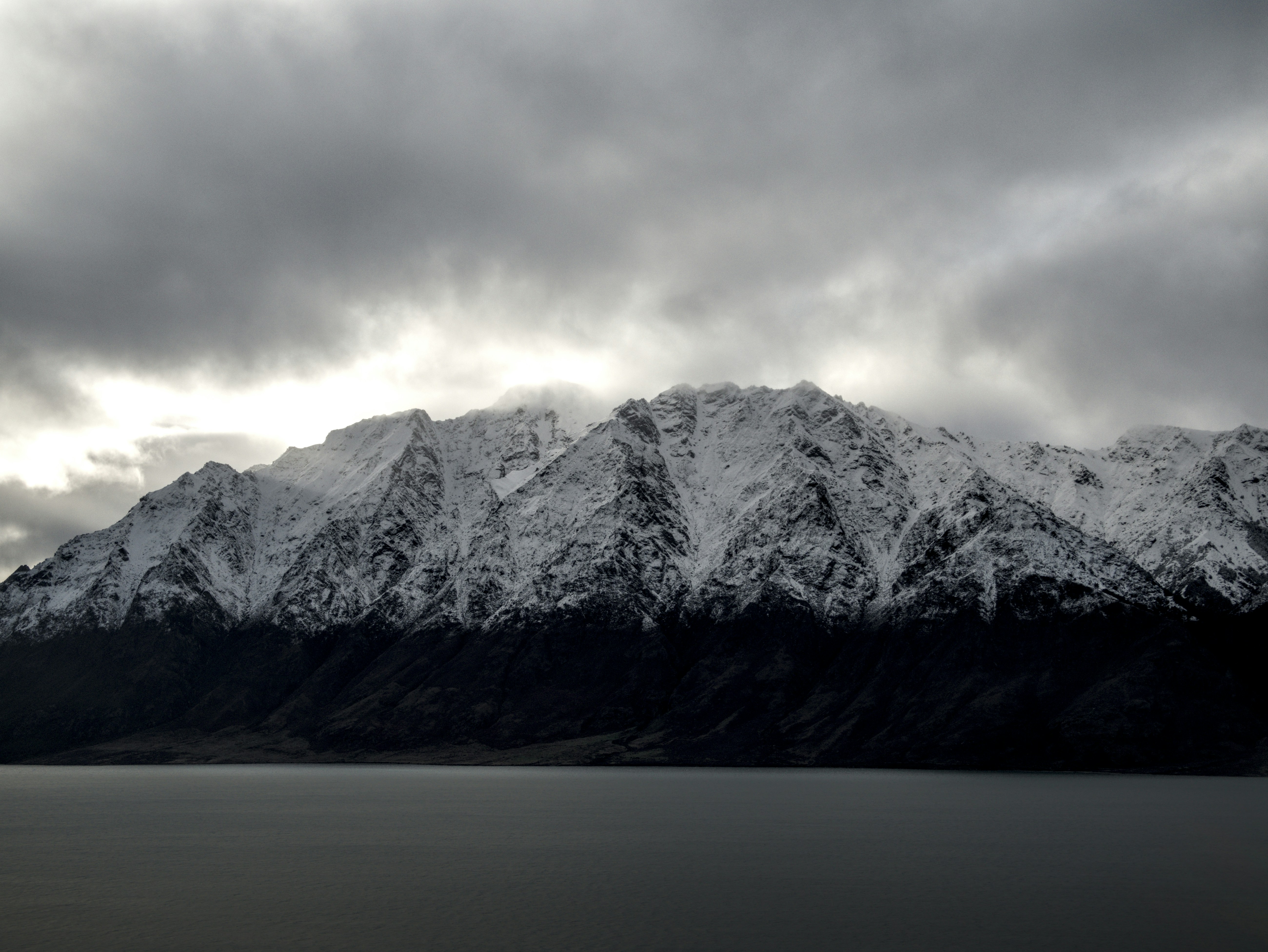 Snow-stitched Peaks Over a Quiet Inlet
