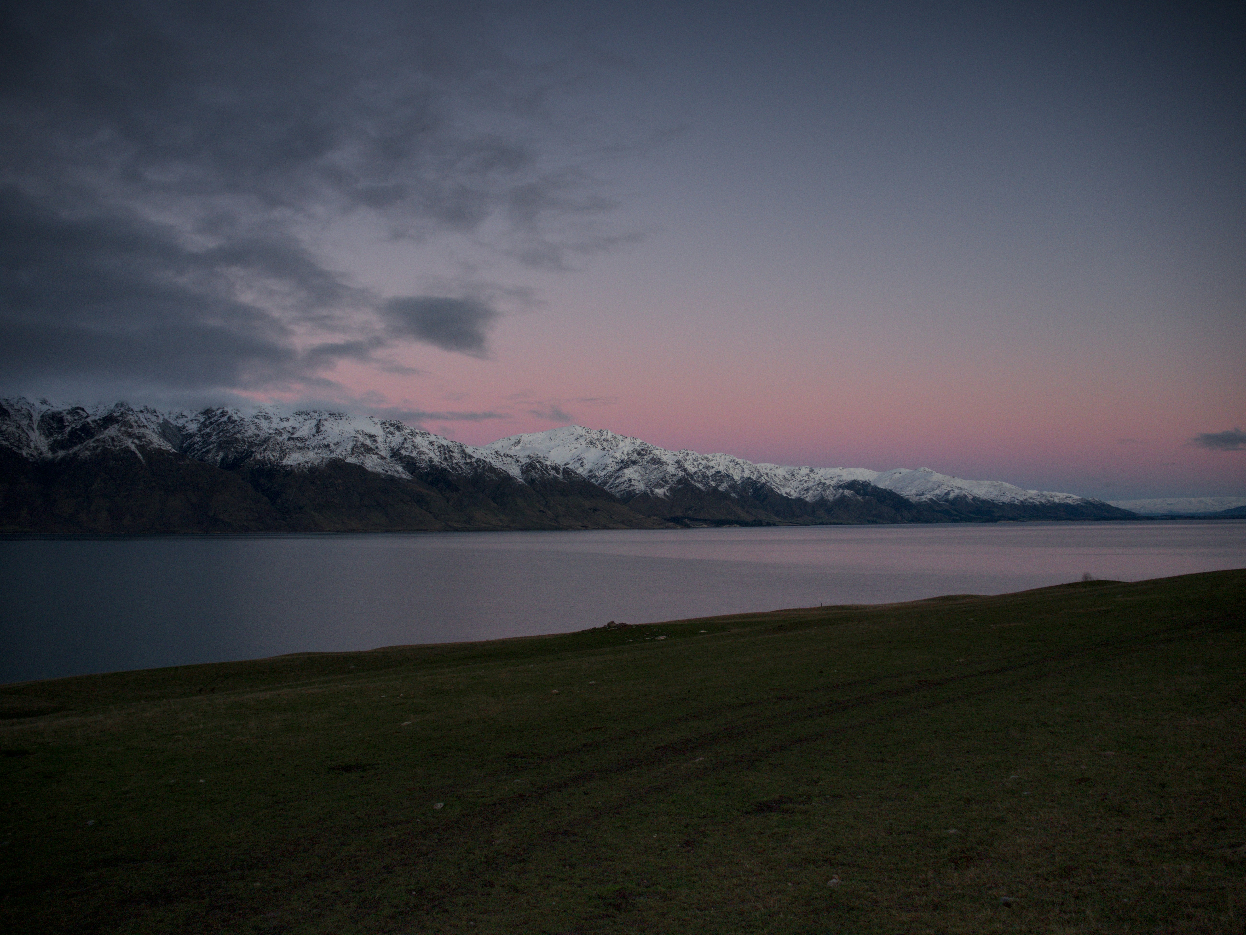 Dusk Over Tranquil Foreshore with Snow‑Capped Ridge