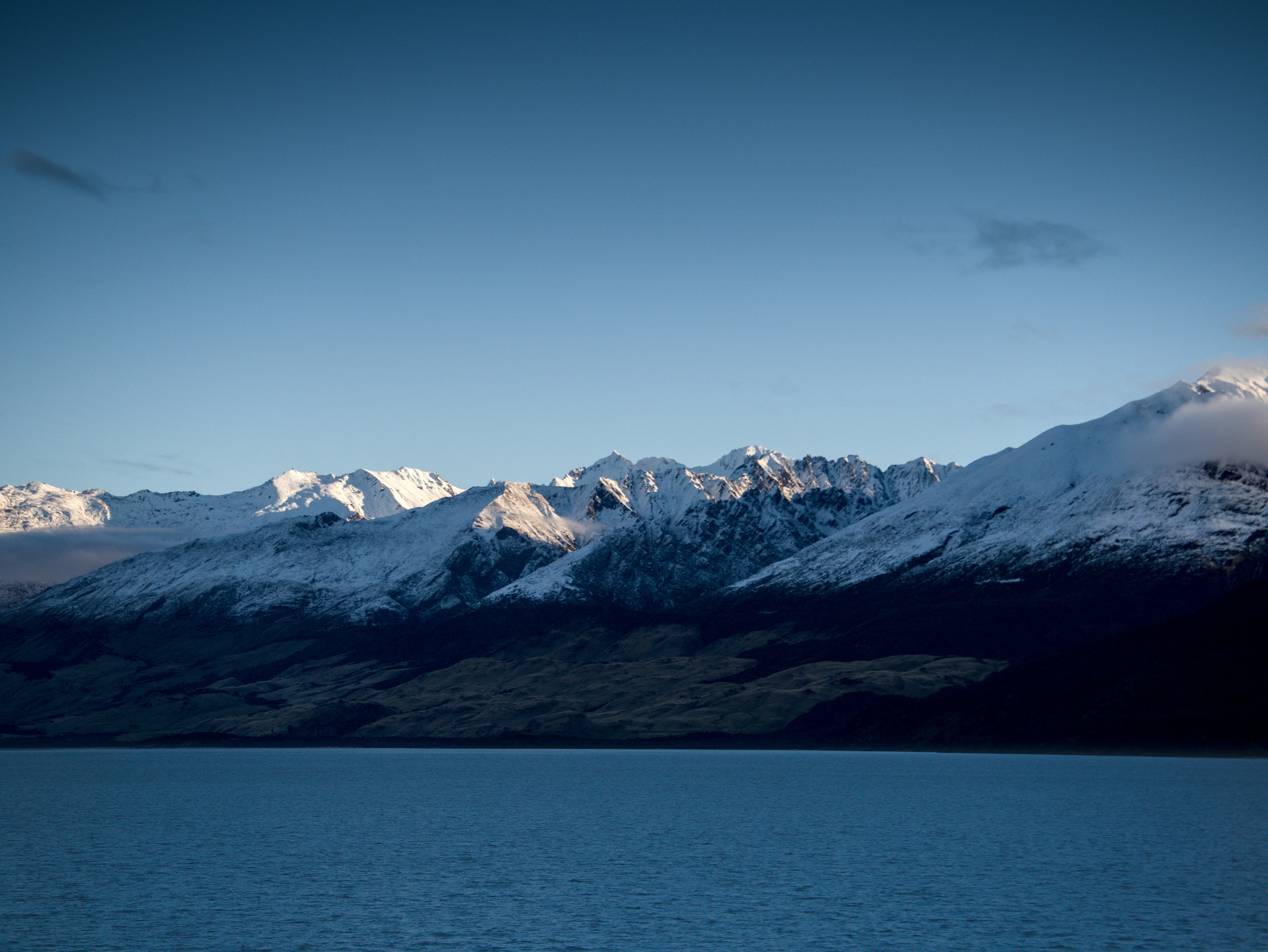 Winter Rim: Sunlit Peaks Over a Quiet Fjord