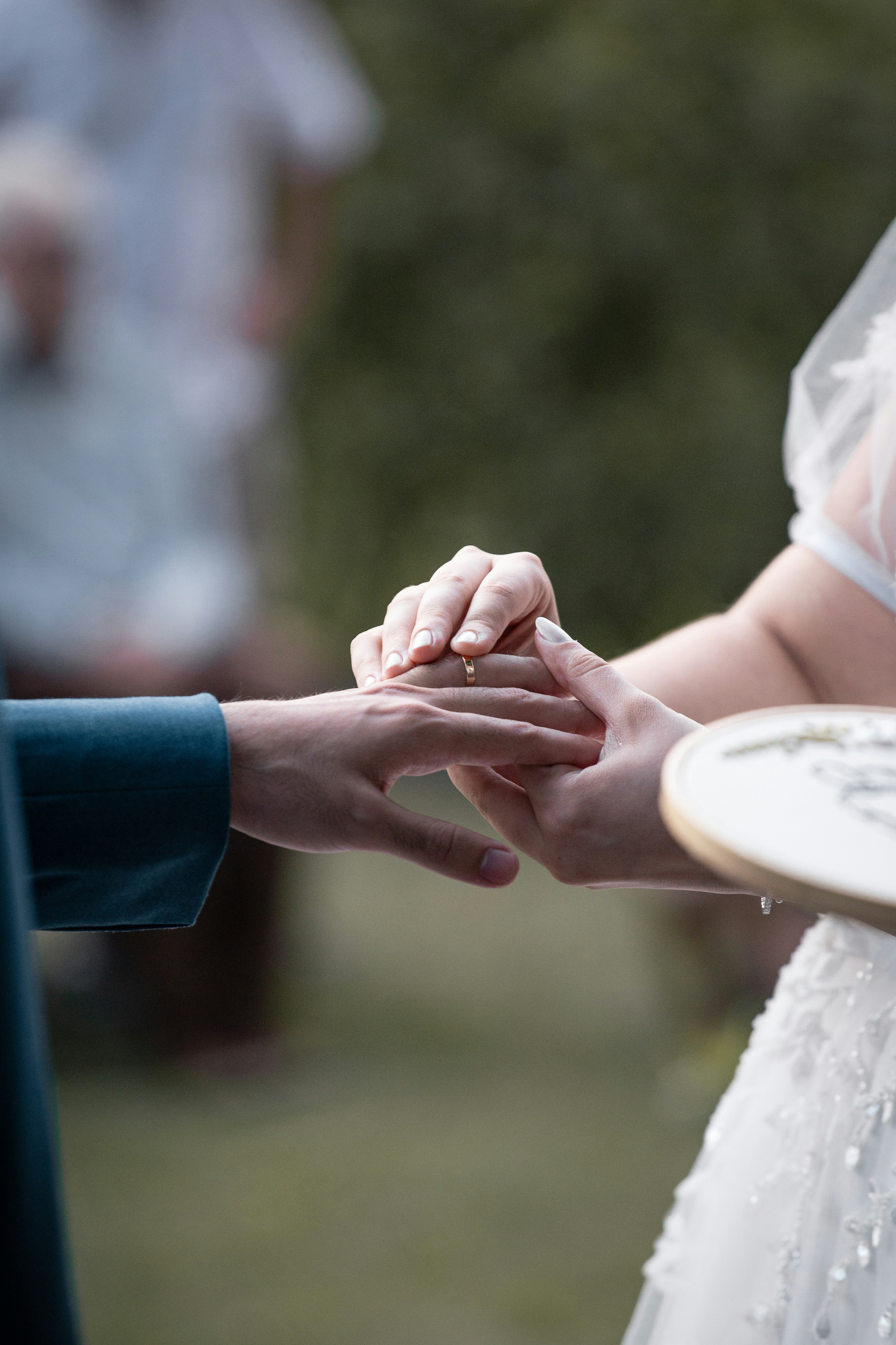 A Quiet Exchange: Hands Meet in Wedding Ceremony