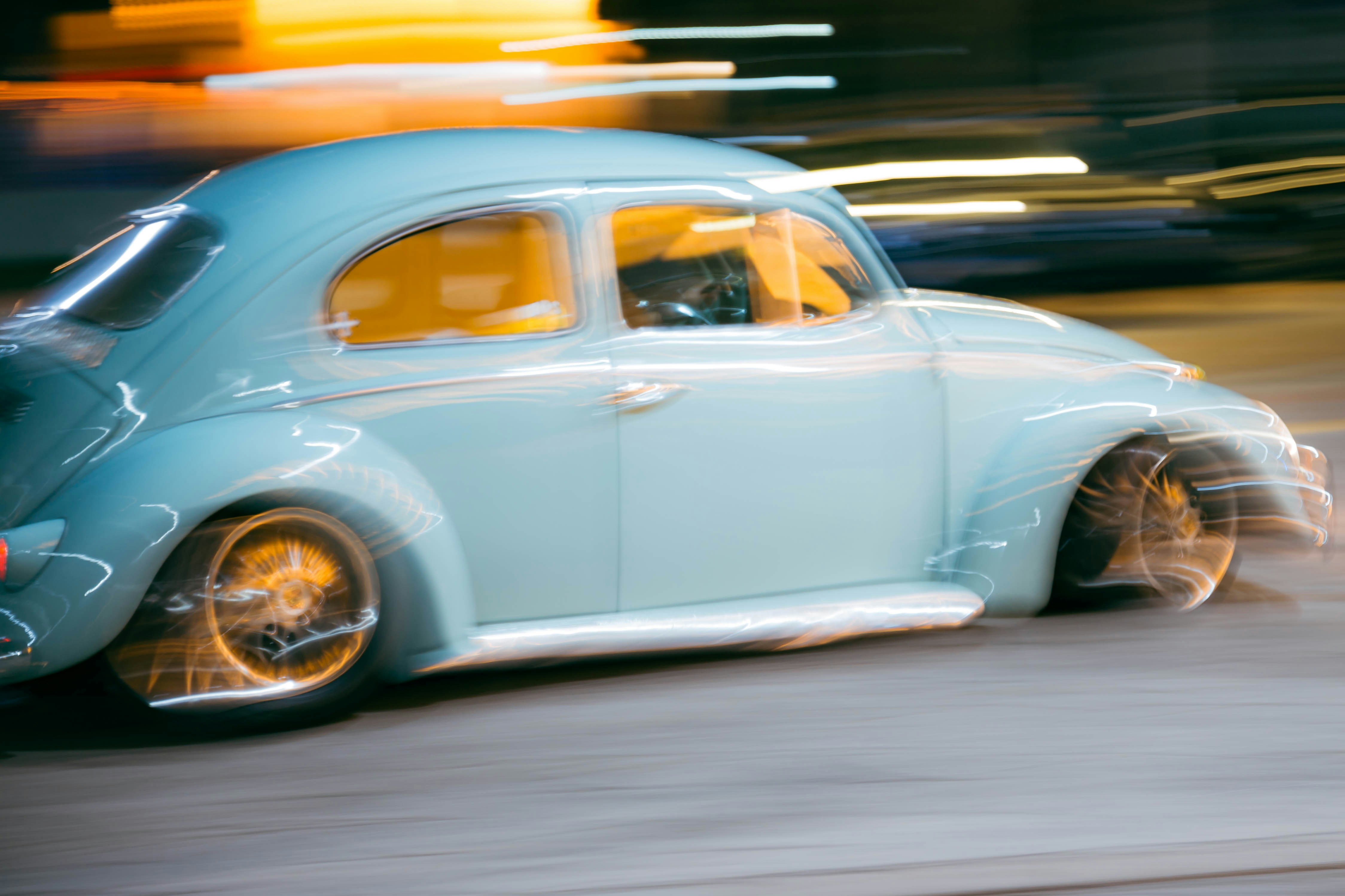 Pastel Blur: A Vintage Beetle in City Motion