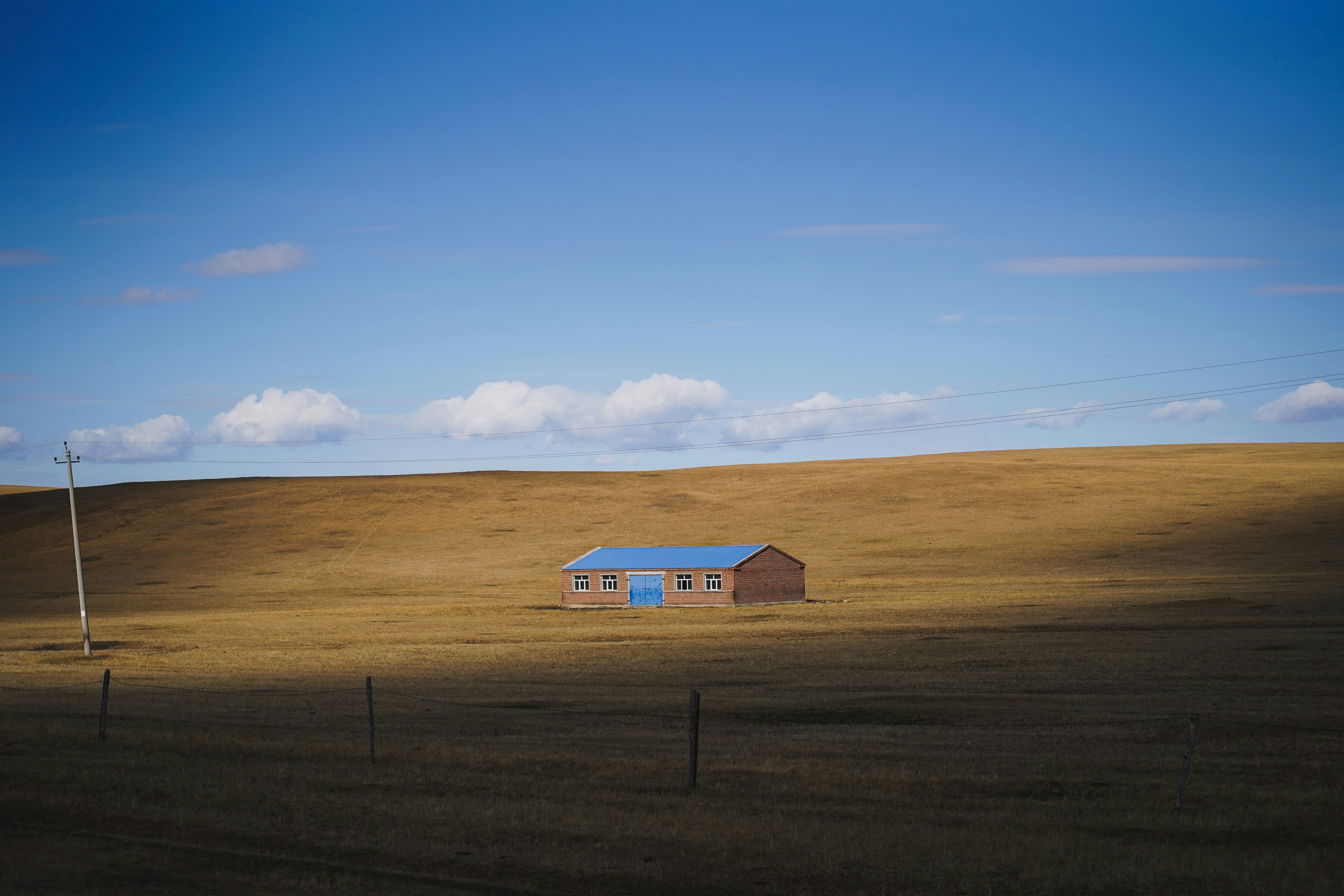 Blue-roofed House in a Quiet Prairie