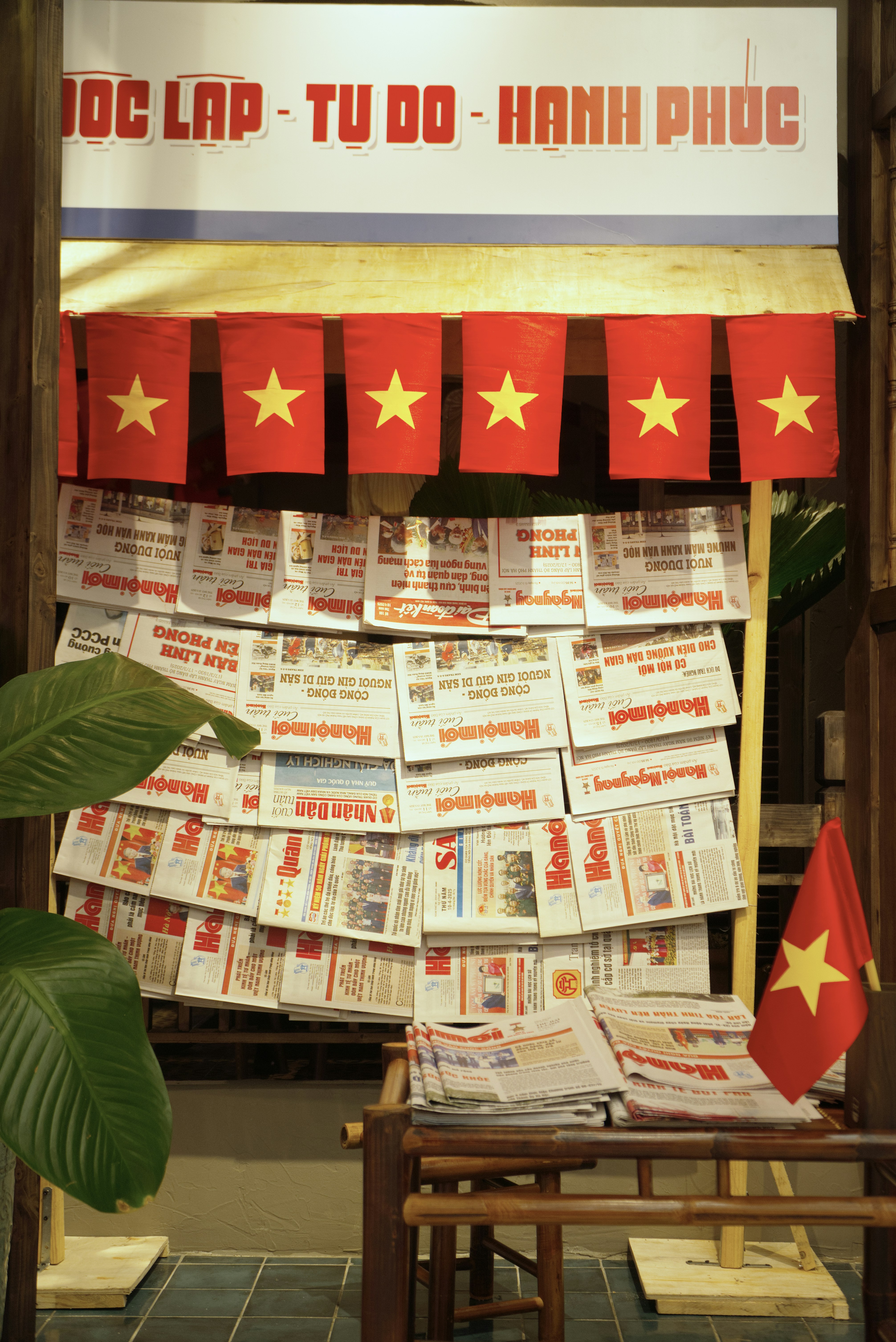 Front Row of Red Stars: Vietnamese Newsstand Under a Banner of National Flags