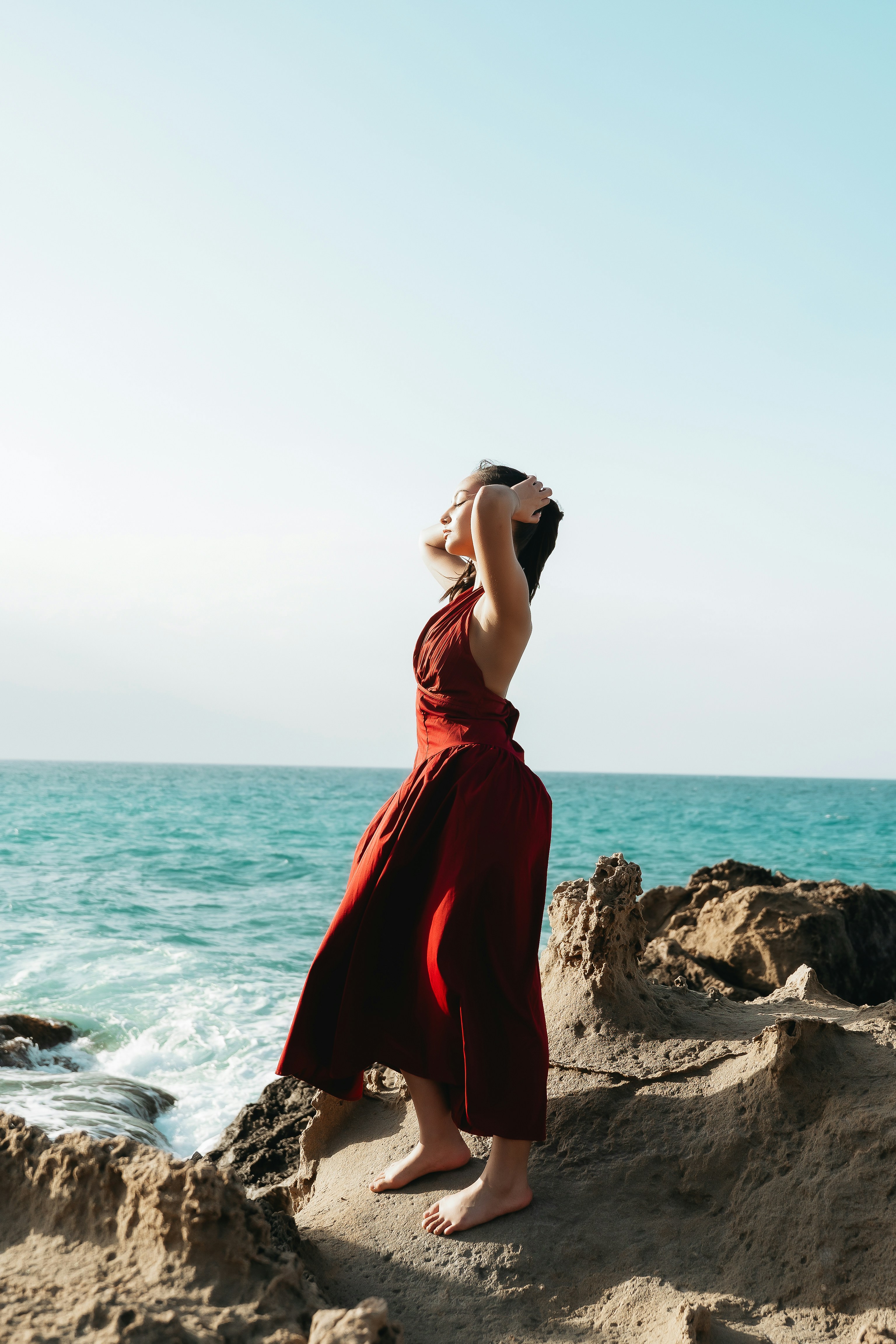 Red Dress on Windward Rock: A Quiet Moment by the Sea