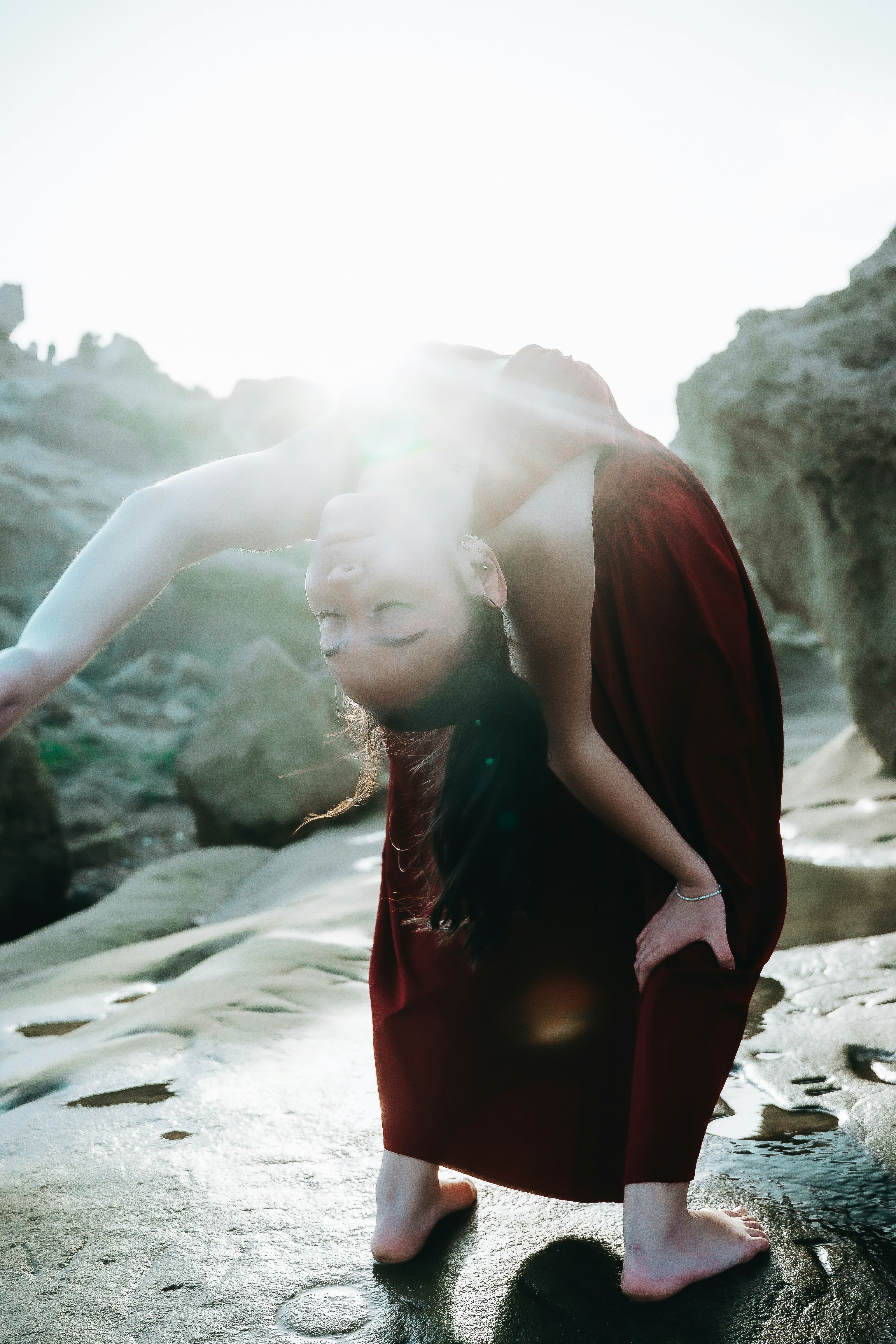 Aerial Leap: The Red Garment Drifts Over Sunlit Shore