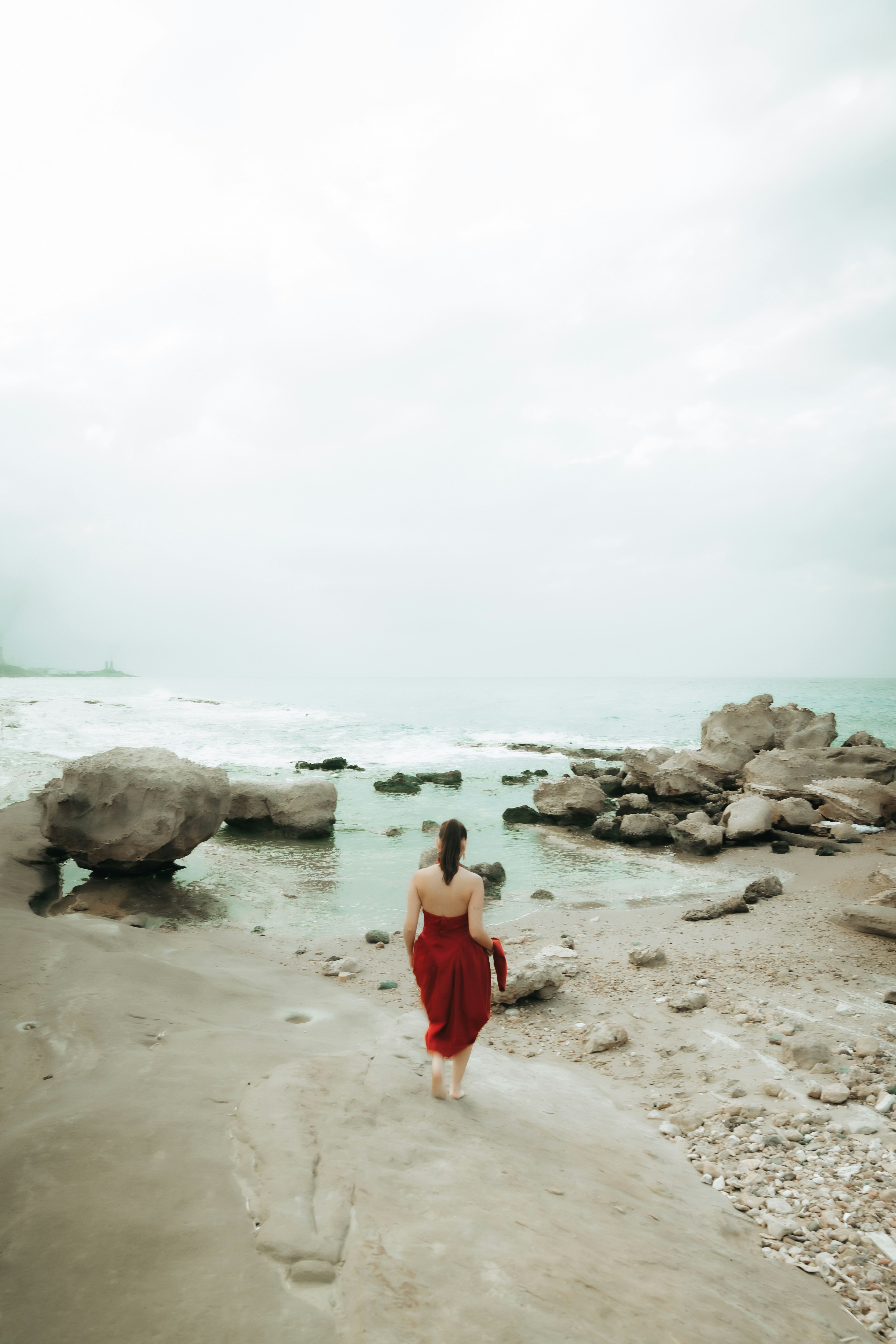 Red Dress on the Shore: A Quiet Descent Toward the Tides