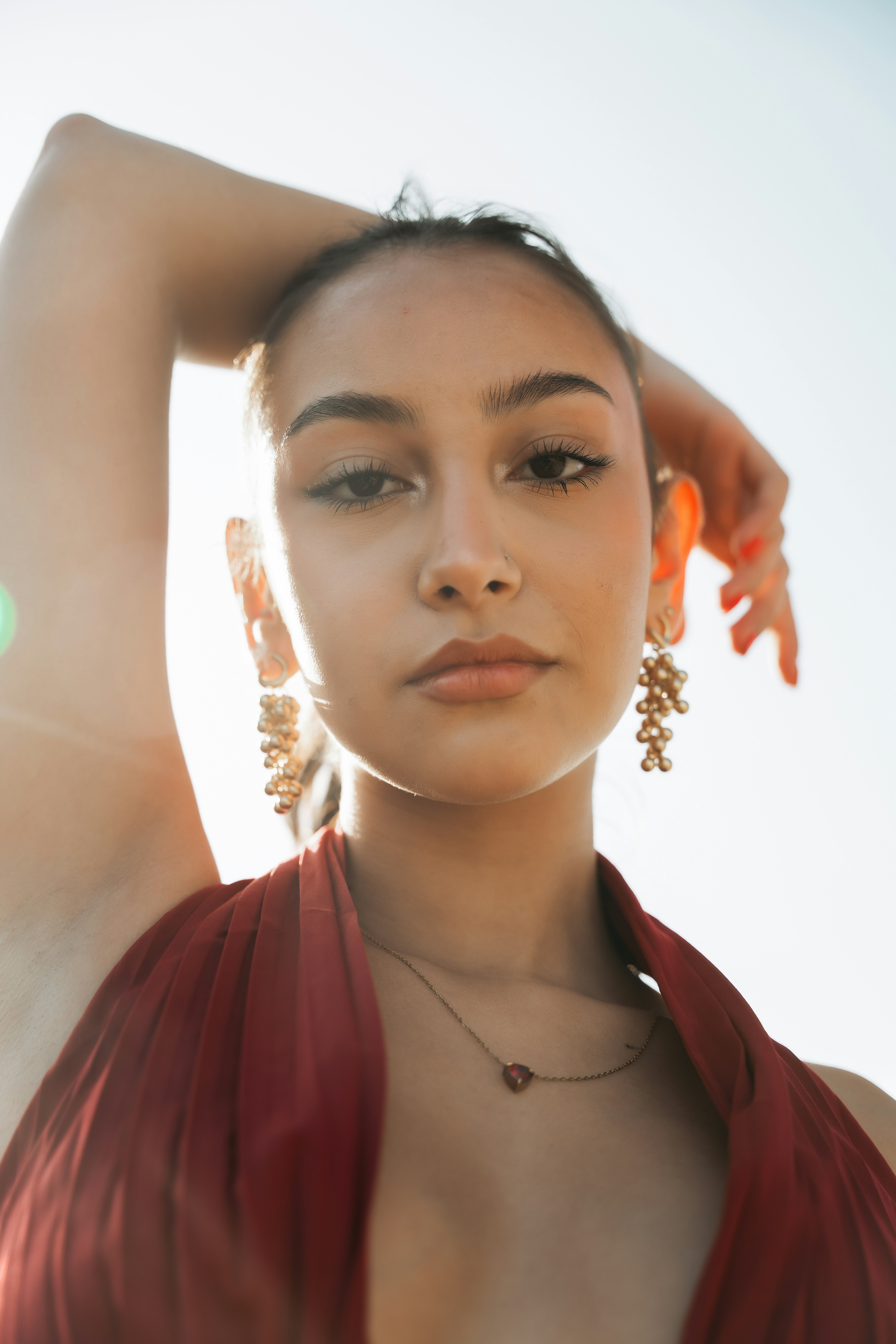 Sunlit Portrait: Graceful Confidence in a Crimson Dress