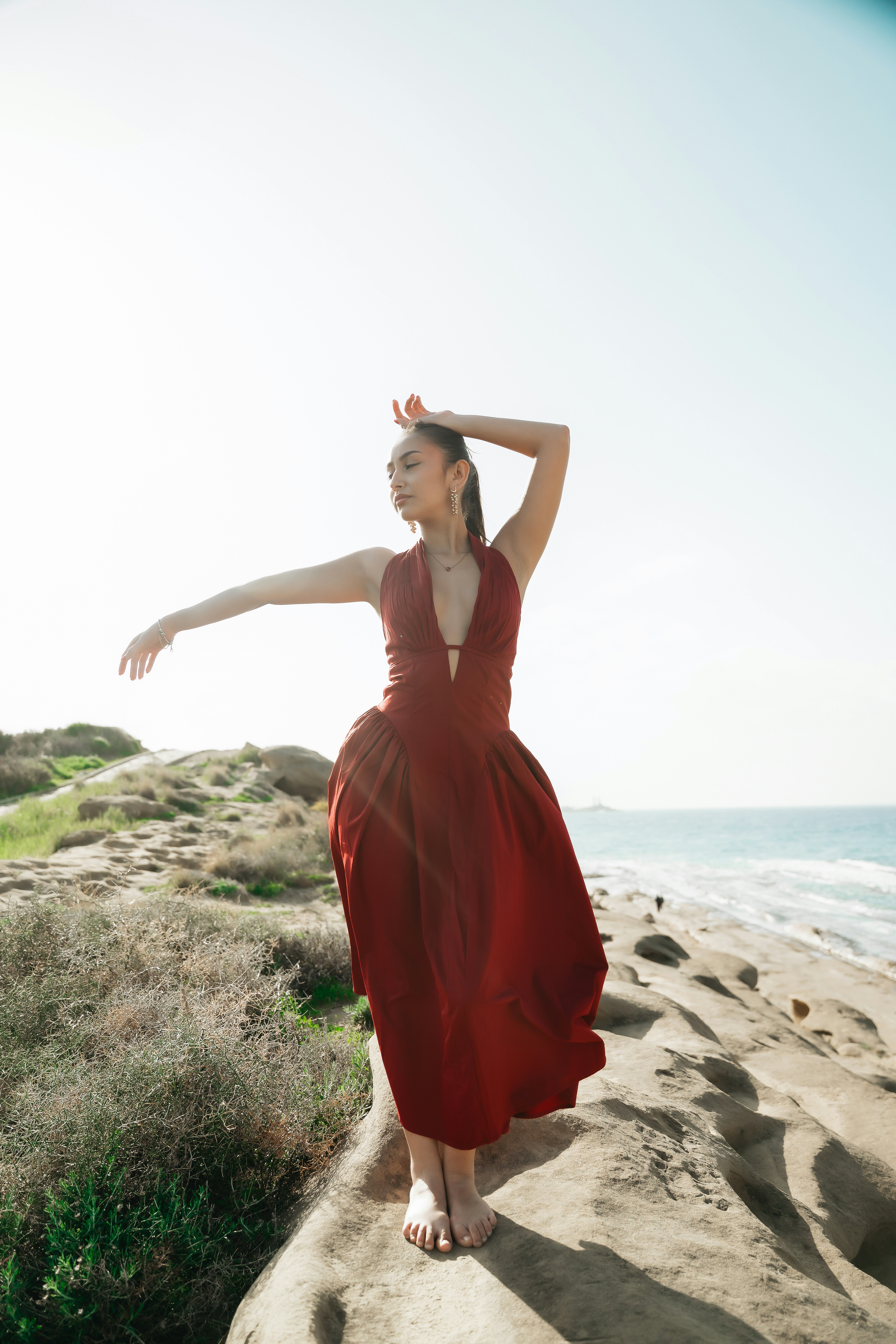 Red Dress on the Edge: Dancing Along the Seaside Cliff