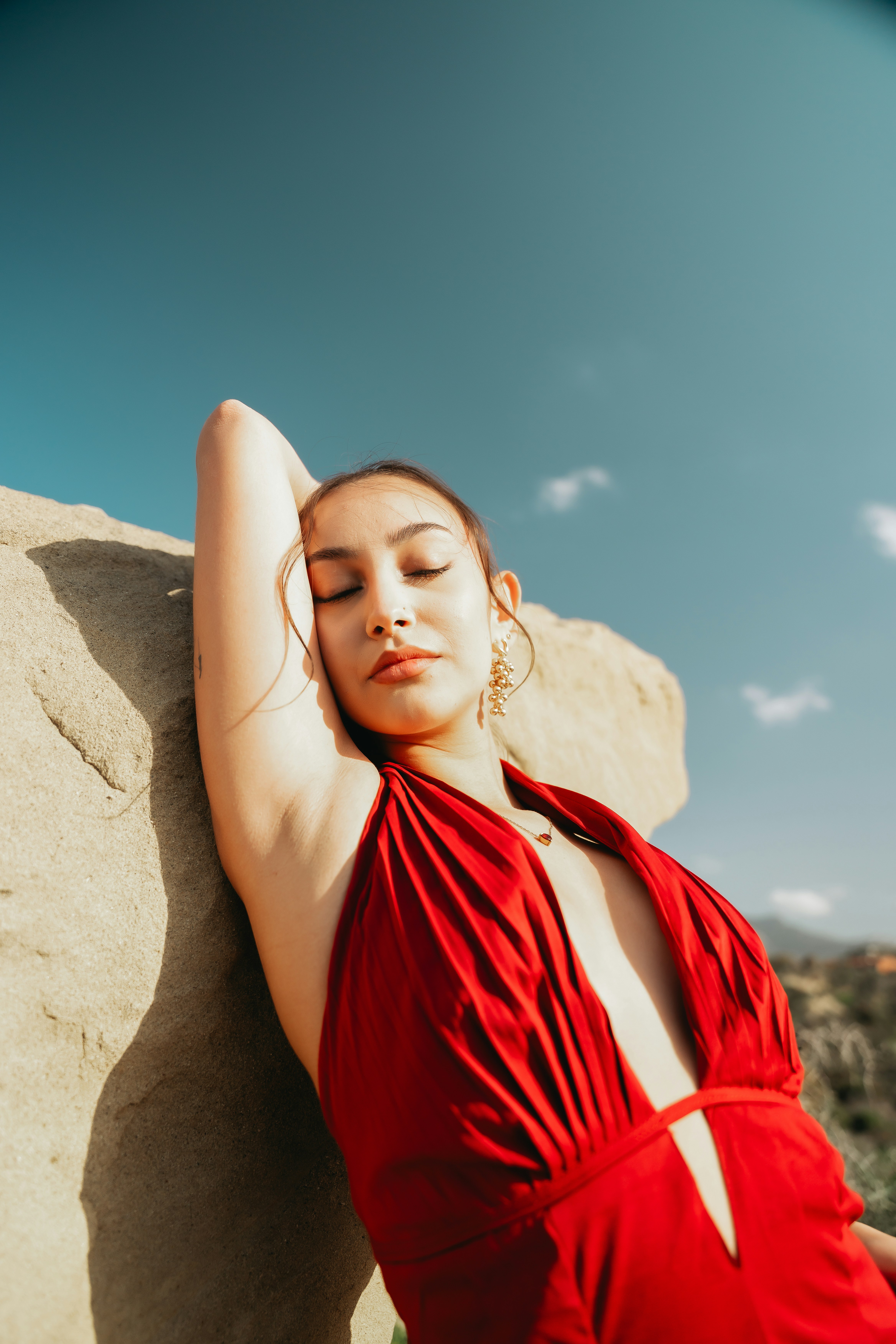 Sunlit Red: A Golden Moment Against Desert Stone