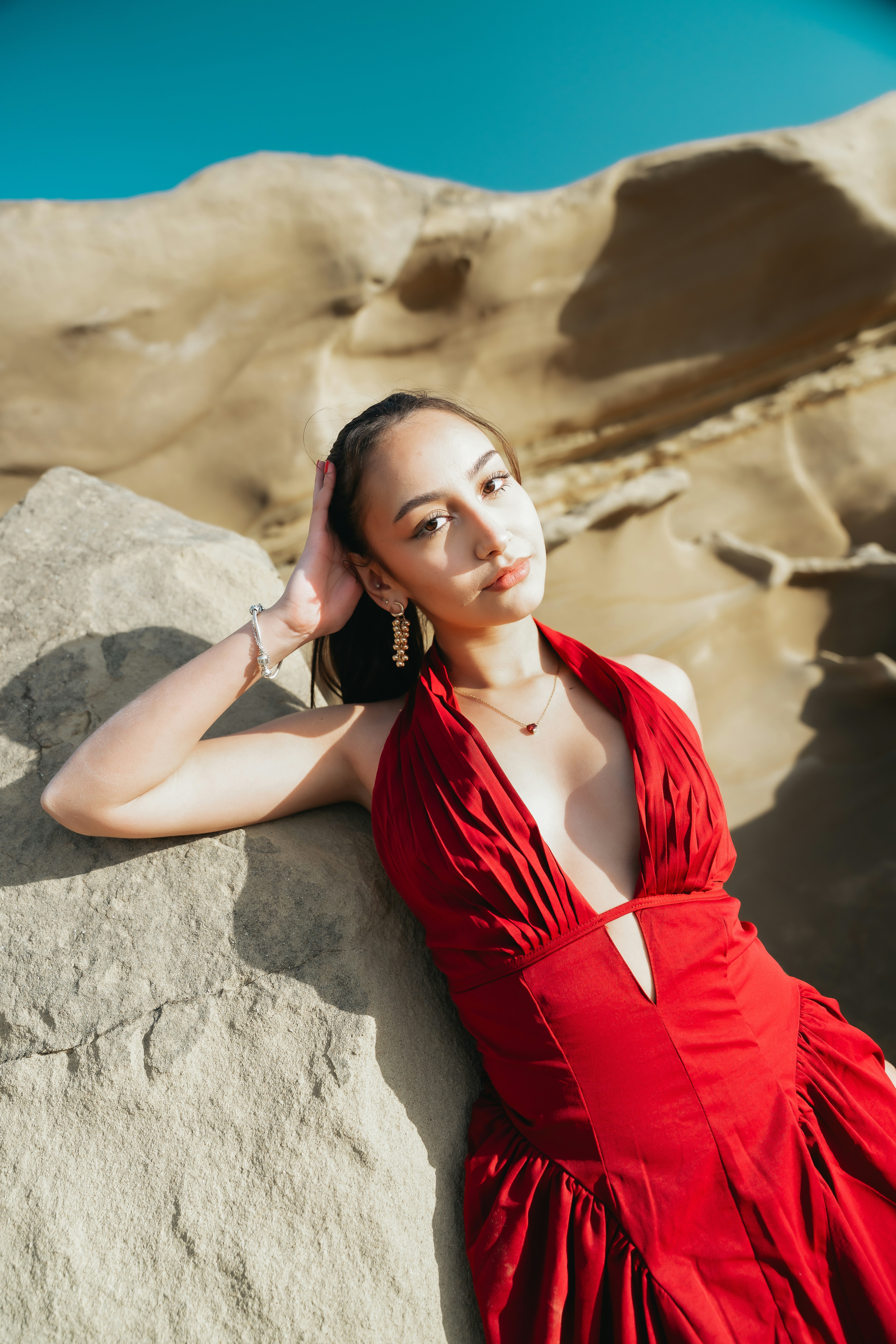 Crimson Evening: Red Dress Against Desert Rock