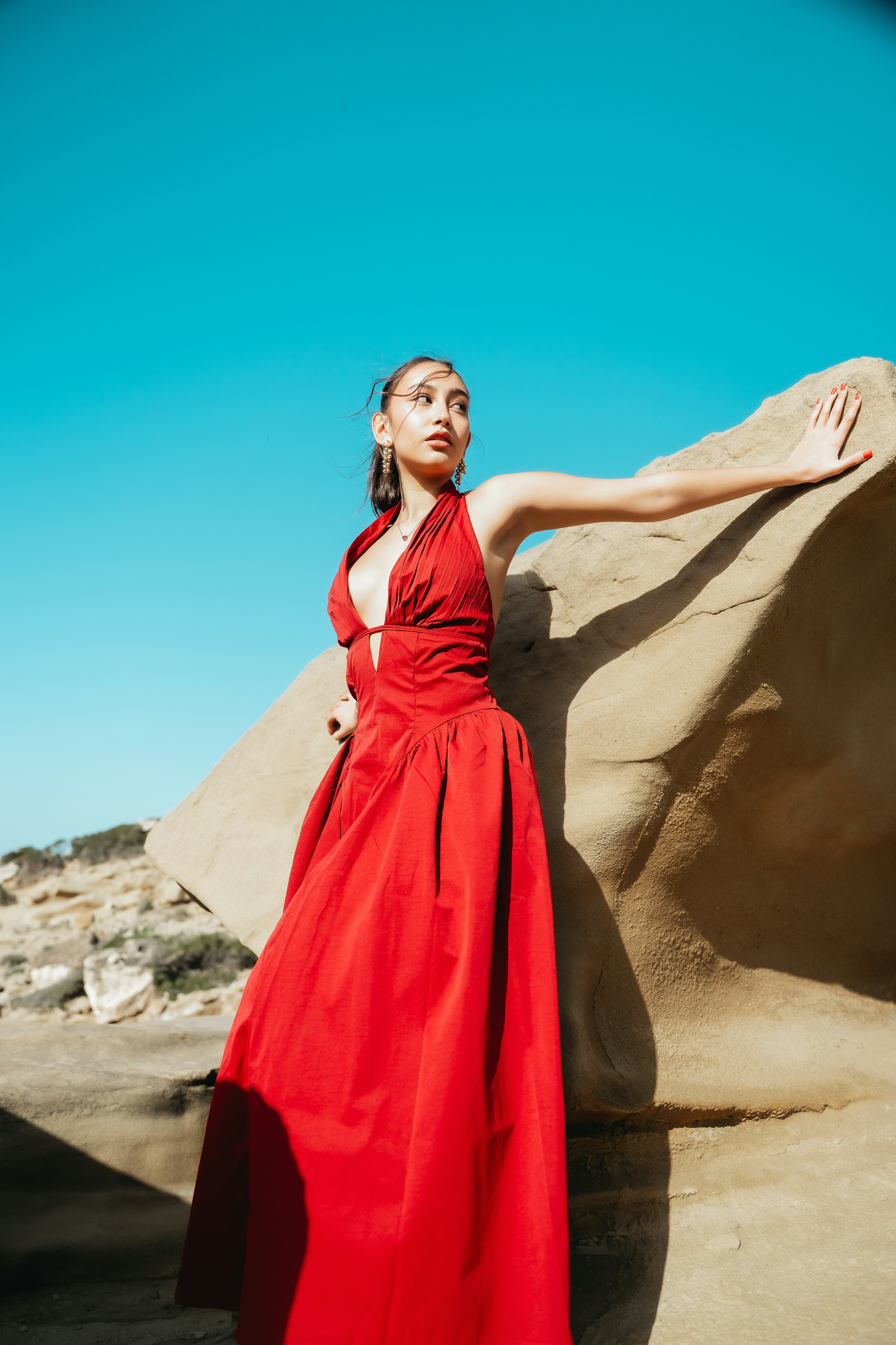 Scarlet in the Sun: A Red Dress Against Desert Stone