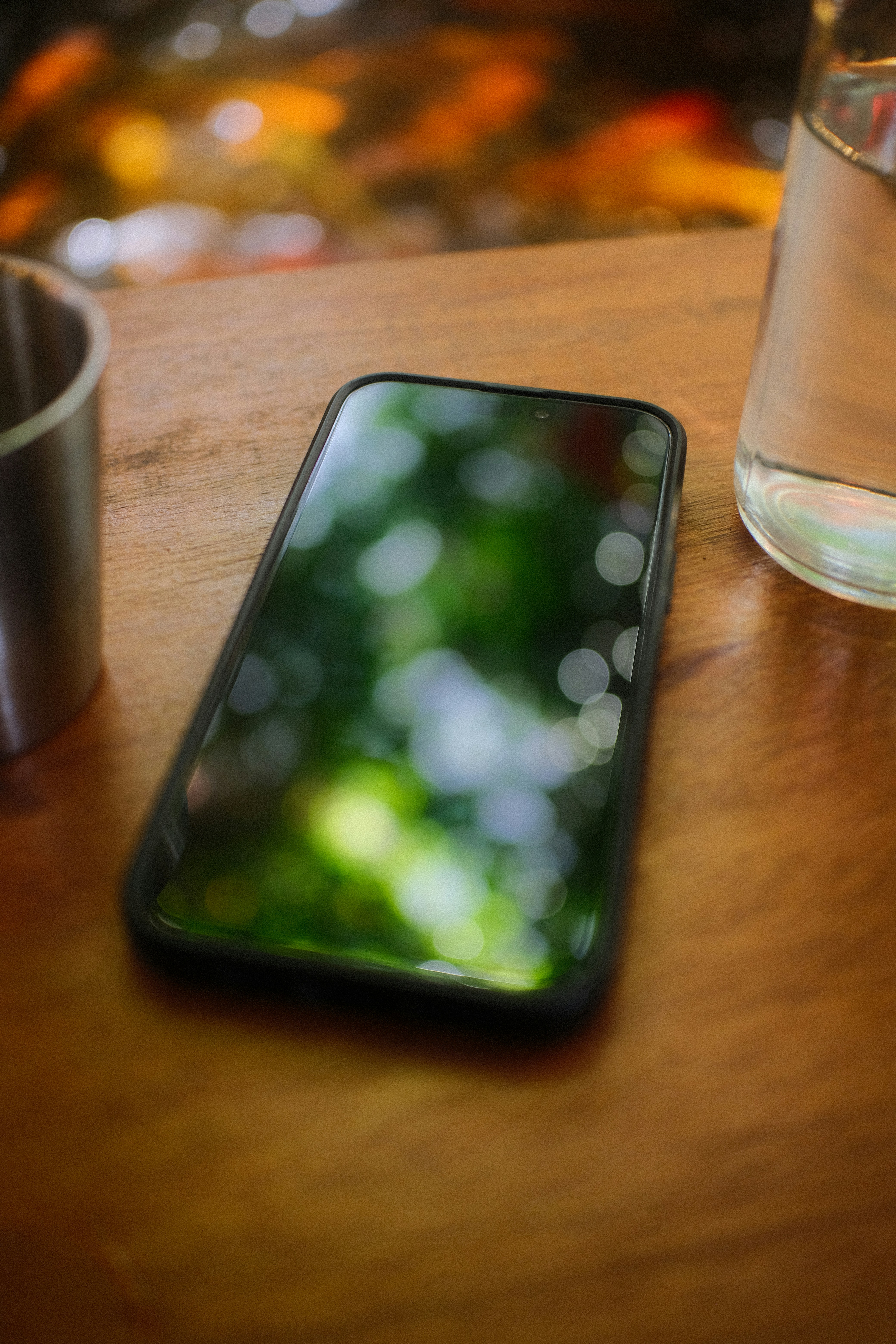 Blurred Focus, Quiet Moment: A Smartphone Resting on Wood