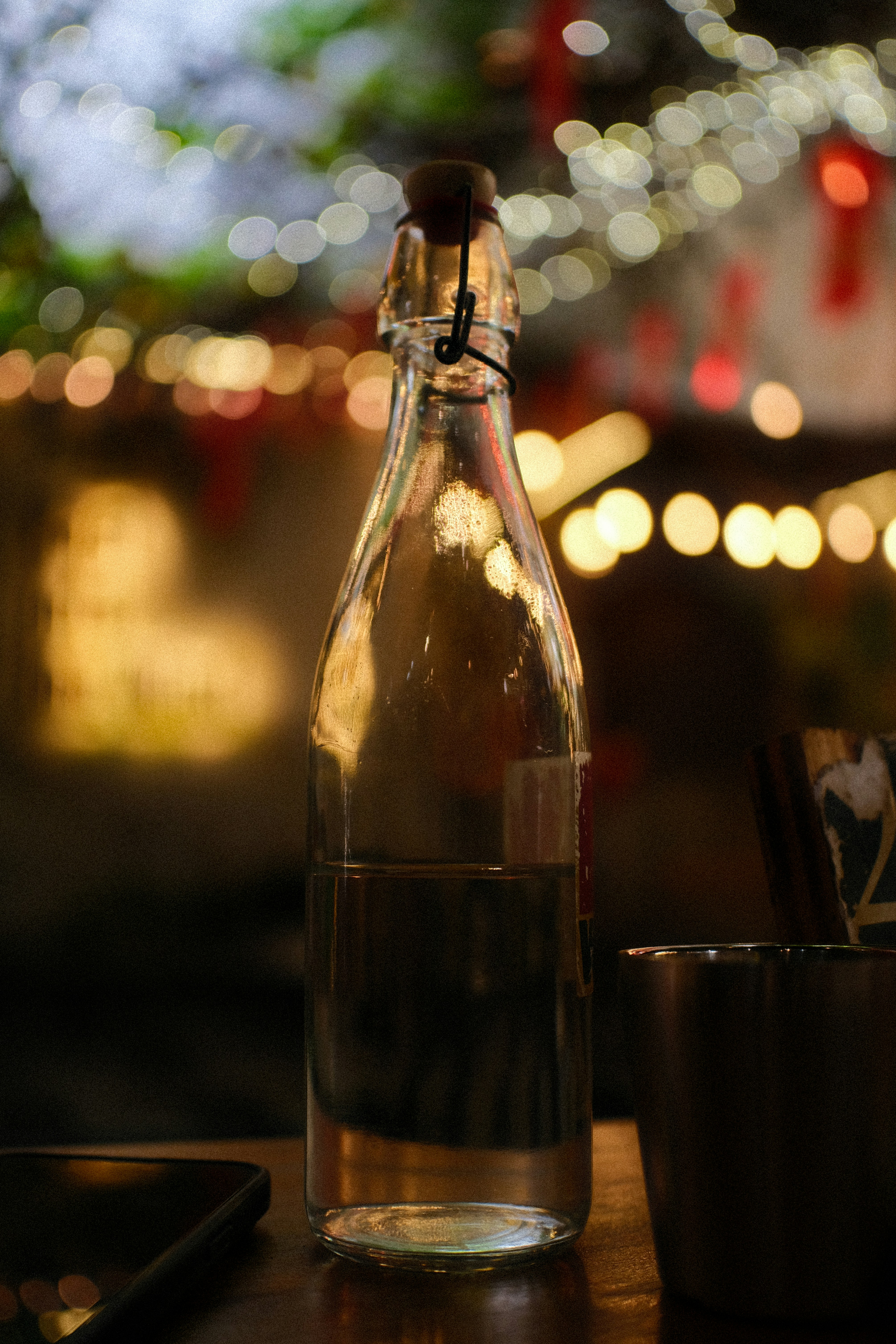 Bottle of Quiet Bubbles Under Warm Bistro Lights