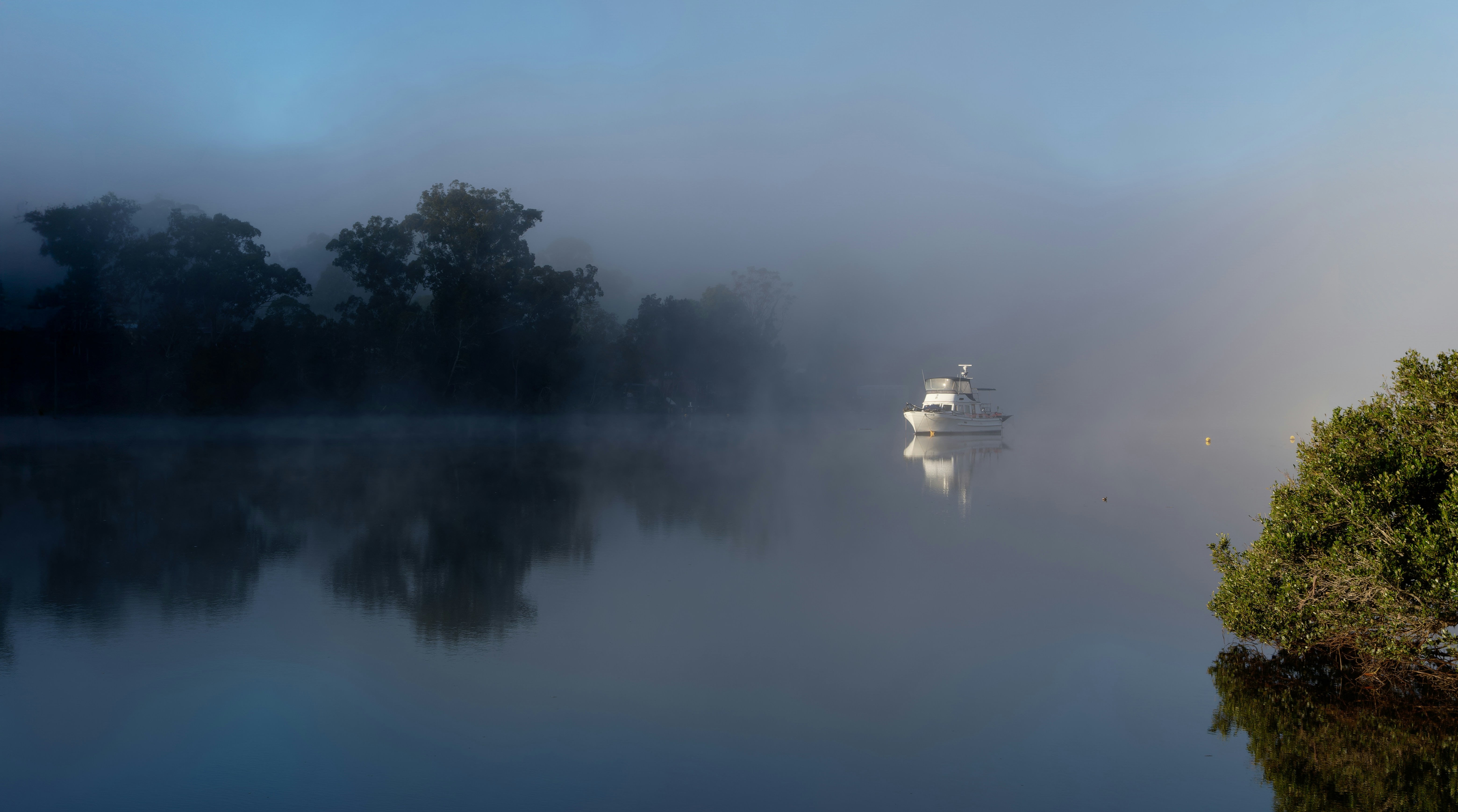 Fog-Wedged Vessel: A Quiet Dawn on Glassy Water
