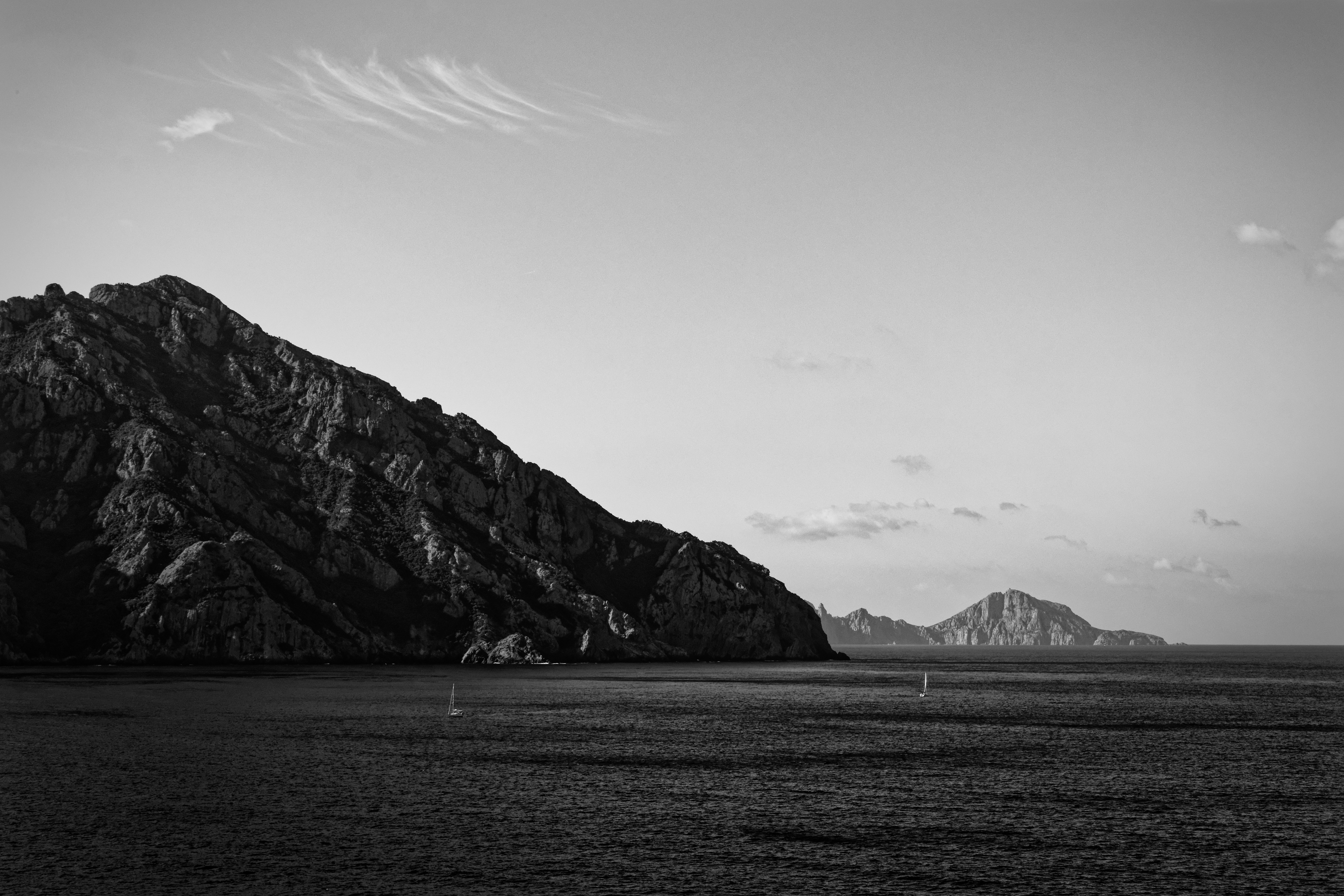 Coastal Ridge at Dusk: A Monochrome Confluence of Sea and Stone
