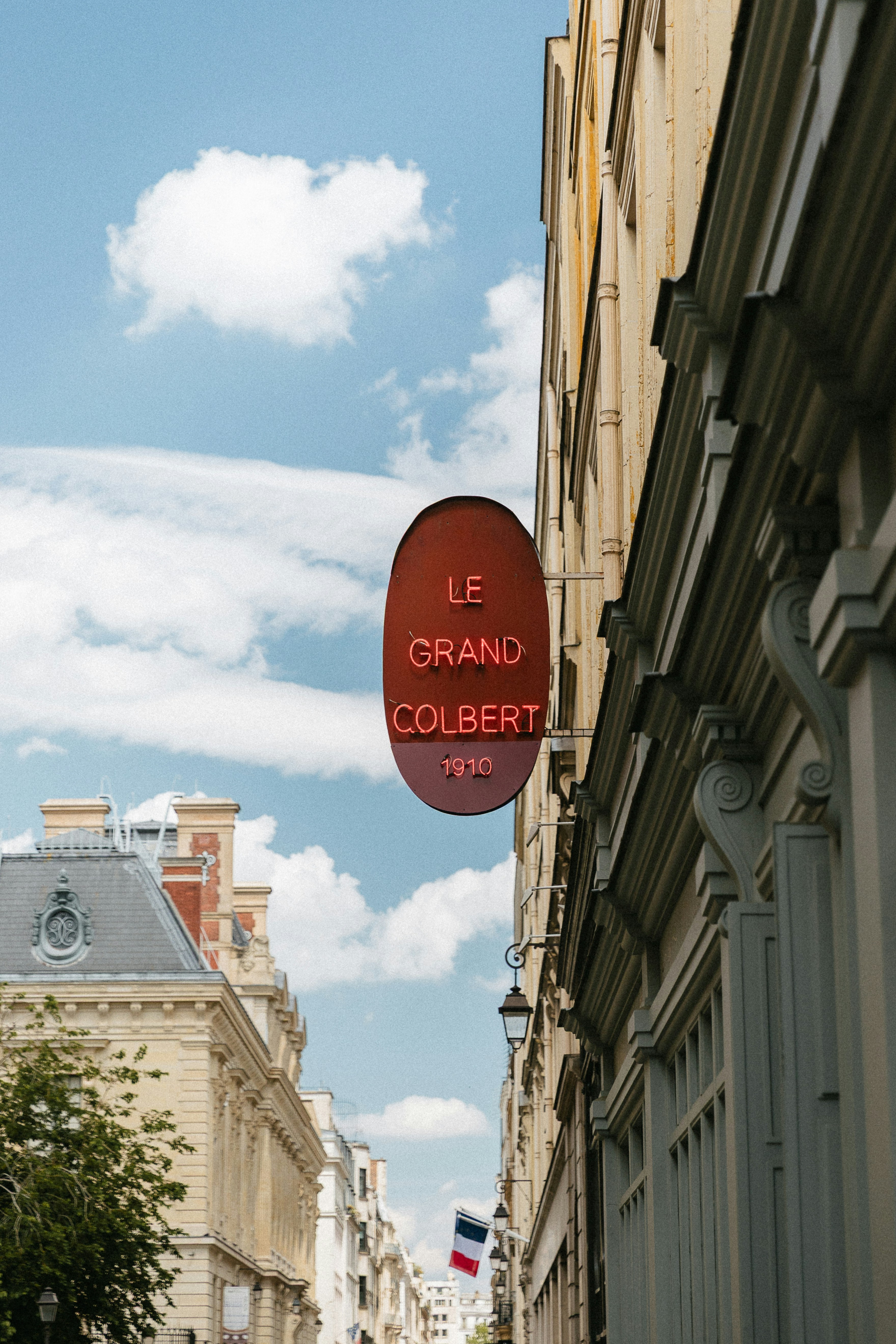 Neon Sign Over a Parisian Facade