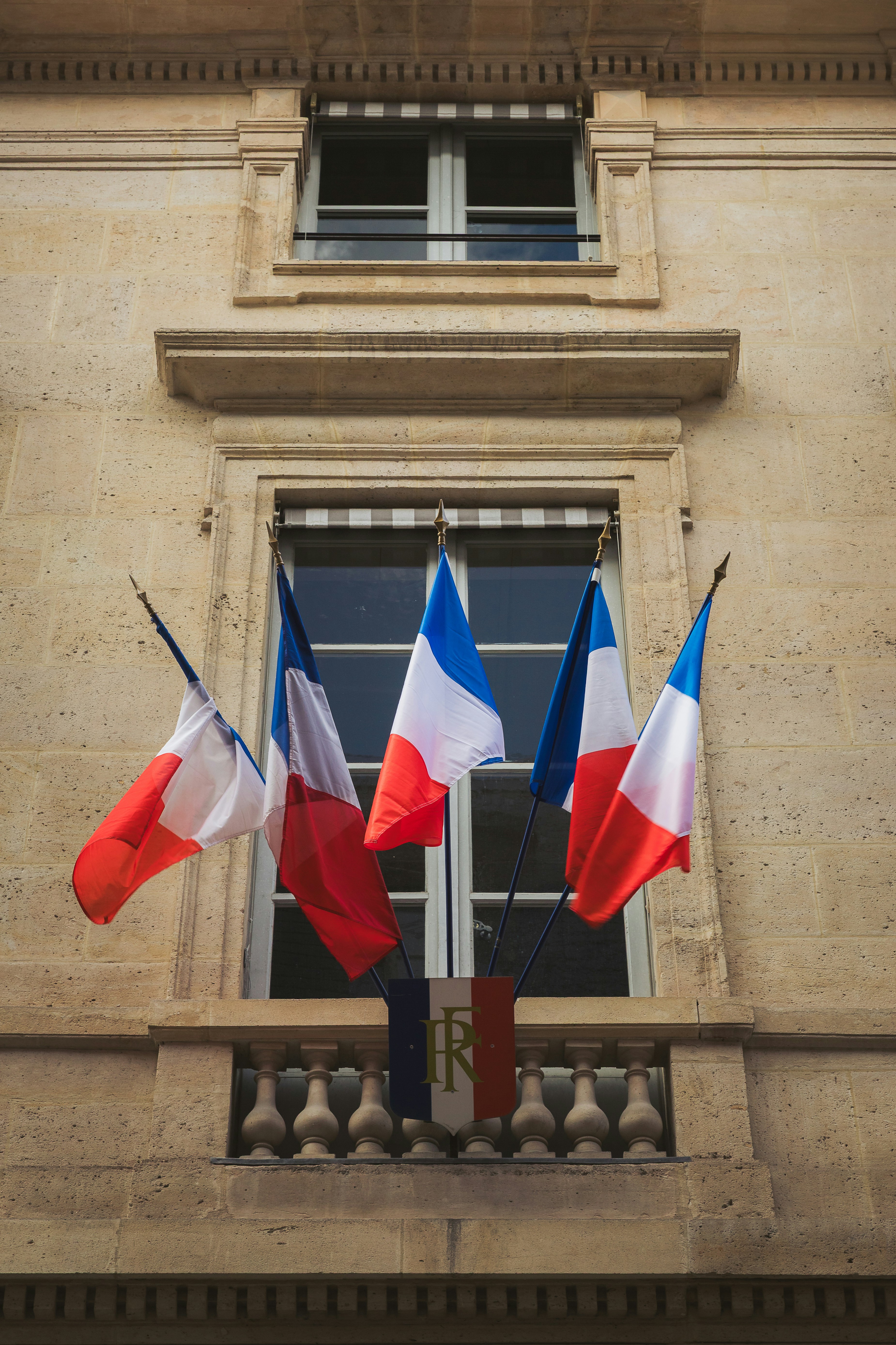 Flags of France Over a Historic Balcony