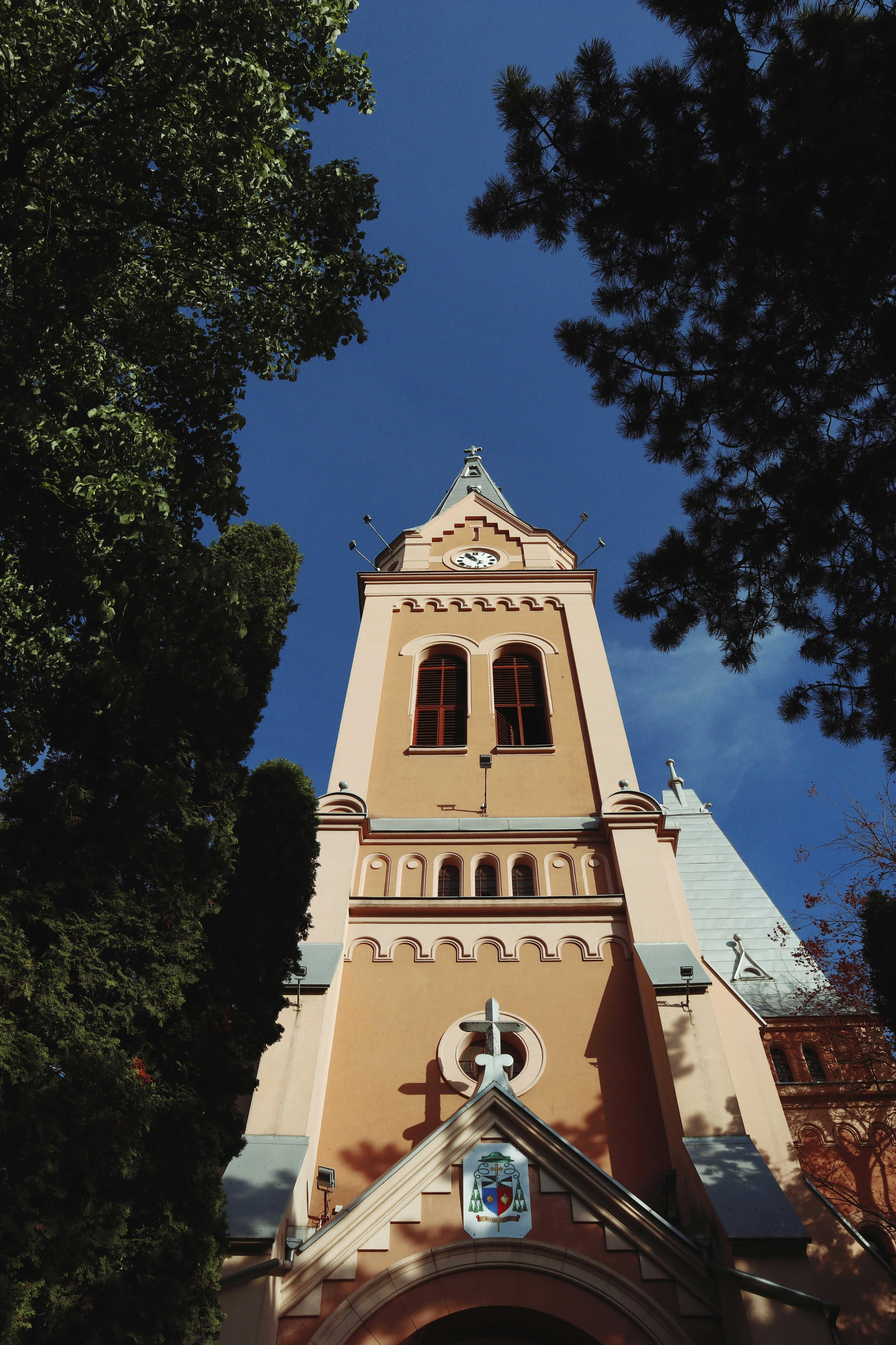 Clock Tower Climb: A Peach Facade Reaches Toward the Sky