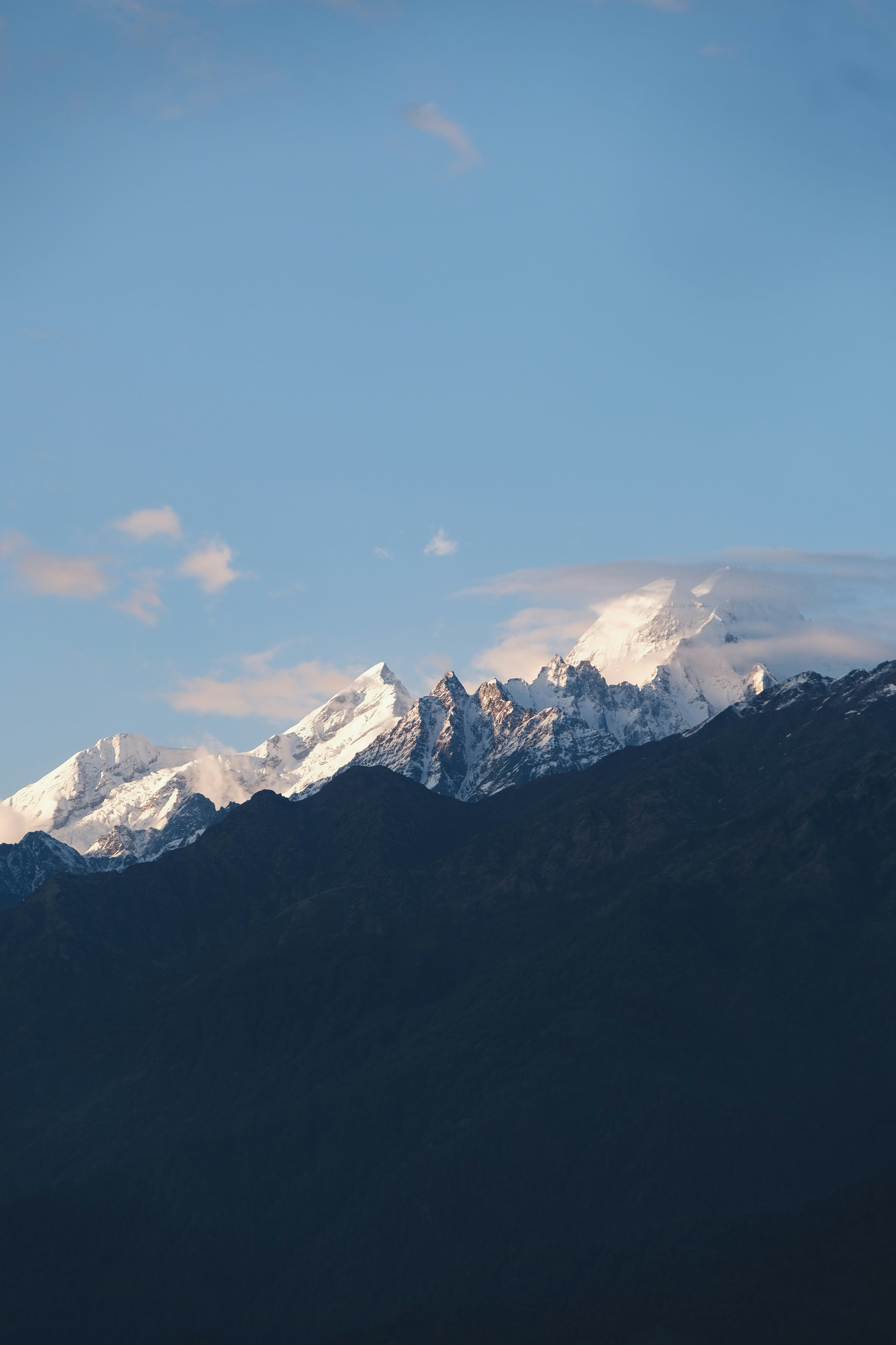 Snow-Crowned Ridge Stretches Across a Quiet Sky