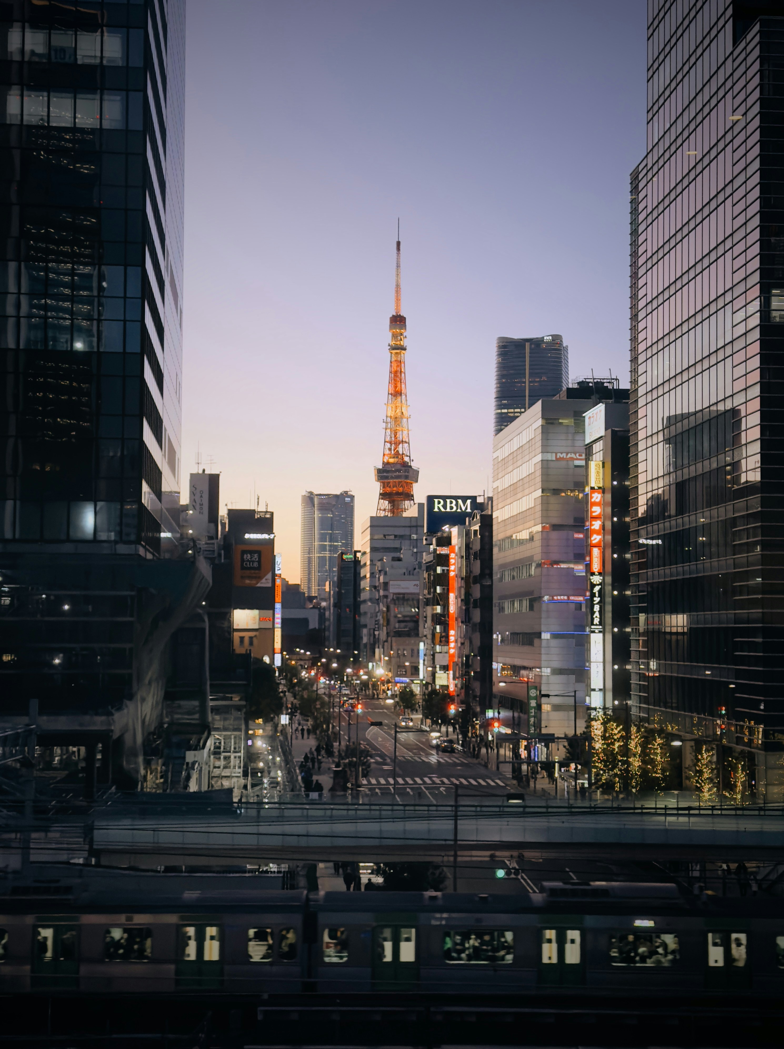 Tokyo Skyline at Dusk with Towering Radio Spire Rising Above Busy Street